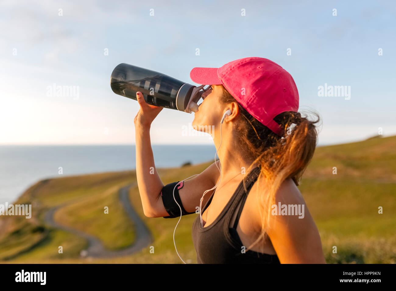Young woman drinking from bottle Stock Photo - Alamy