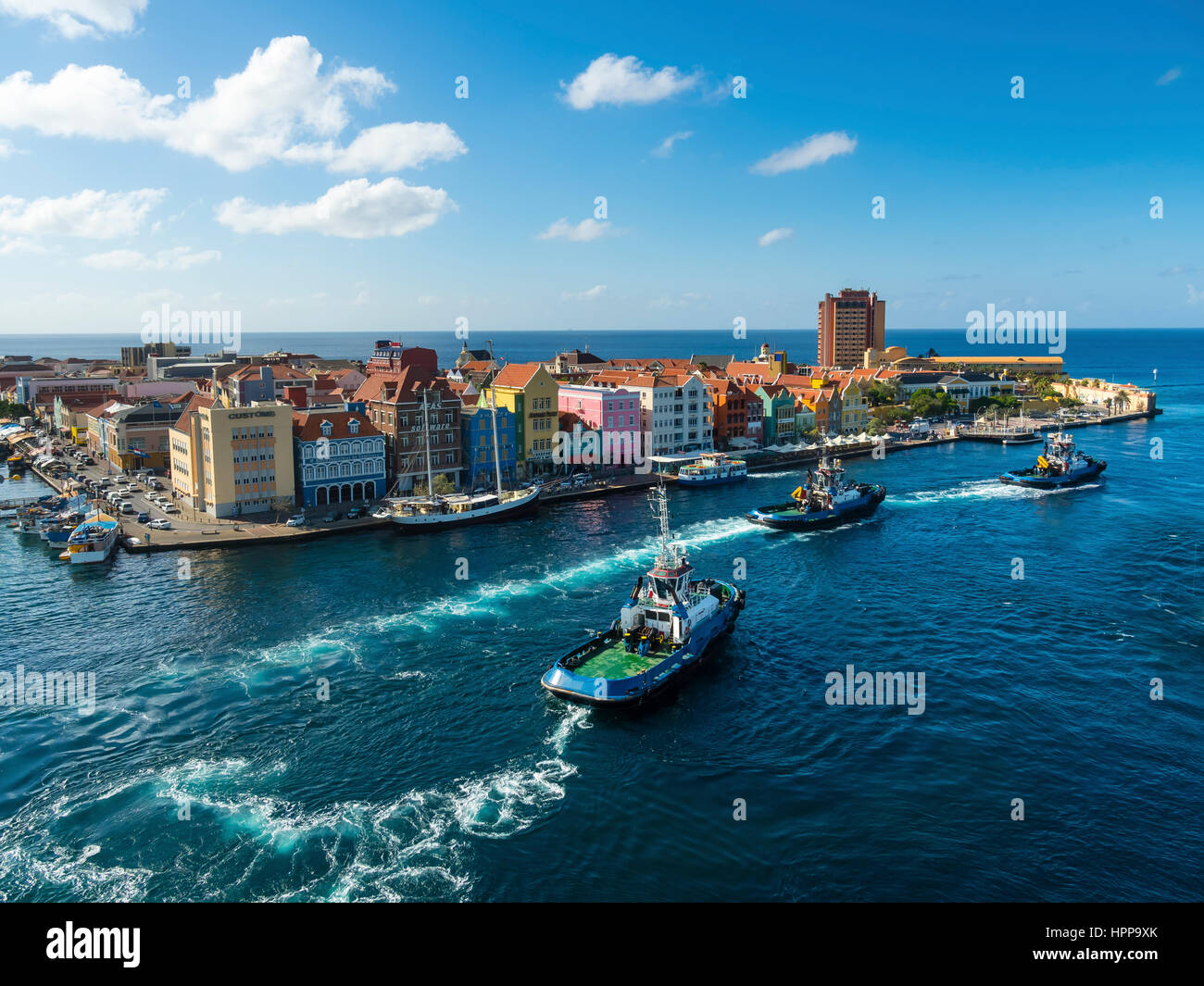 Curacao, Willemstad, Punda, tugboats and colorful houses at waterfront ...