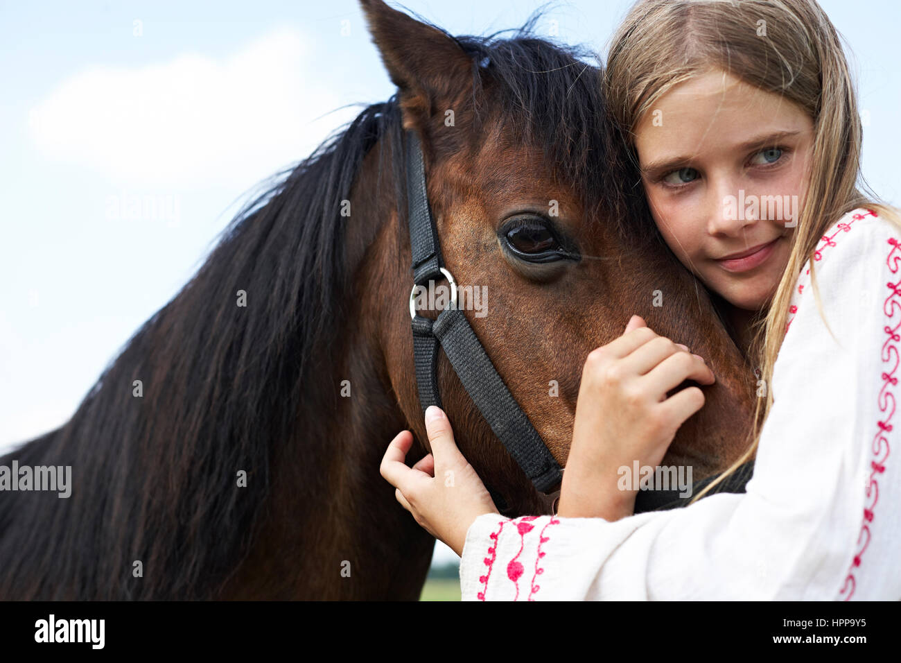 Happy girl hugging horse Stock Photo - Alamy
