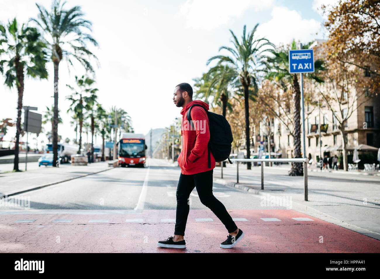 Young man in the city crossing the street Stock Photo - Alamy