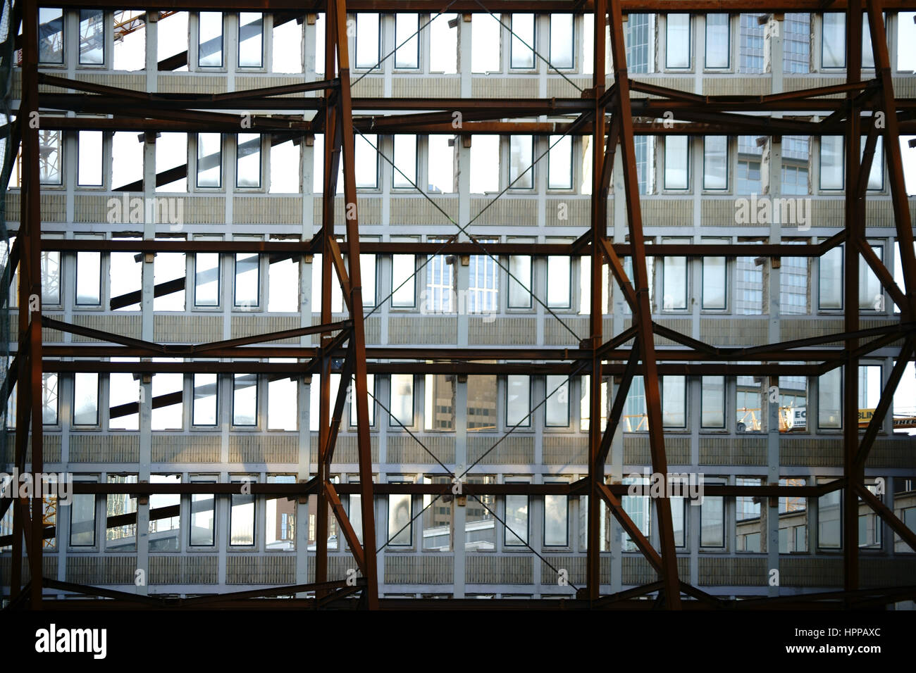 A heavy iron construction supports a single wall of a demolished high ...