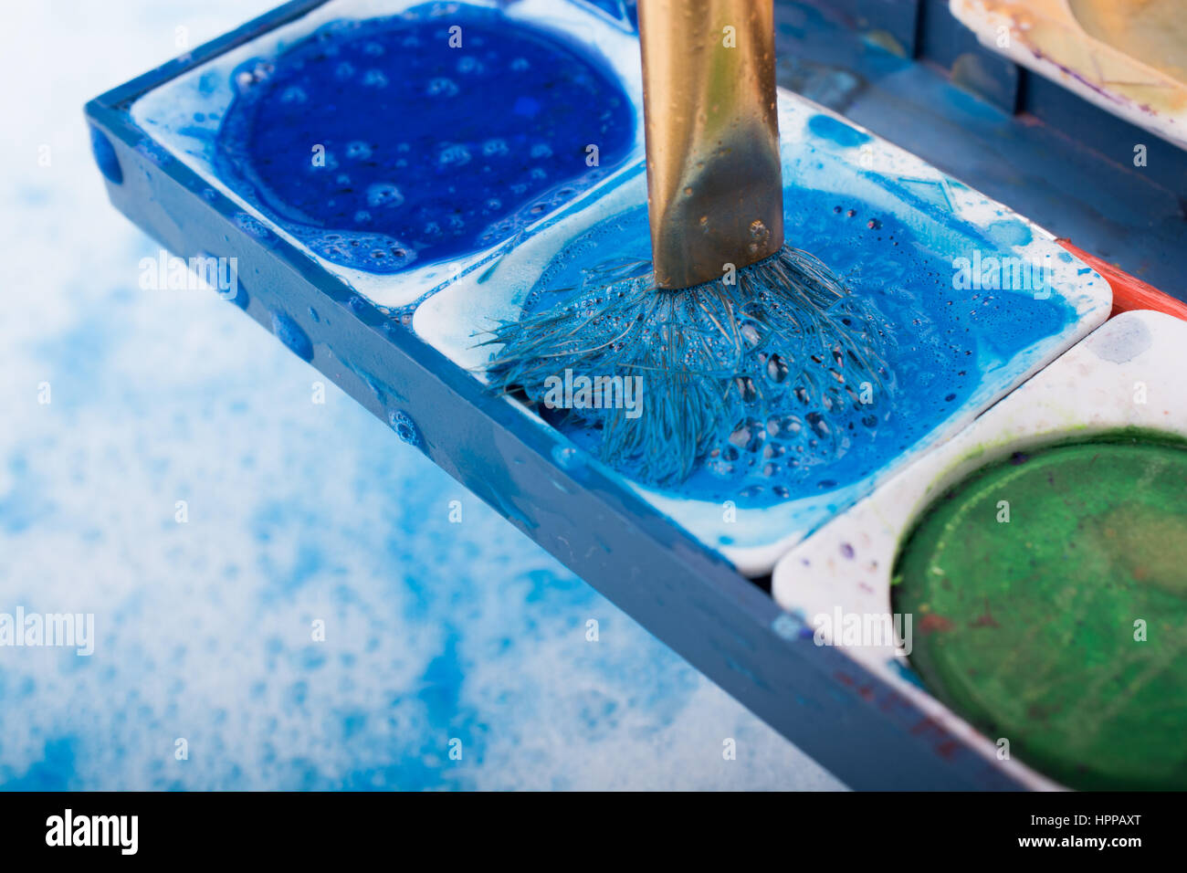 Watercolor paint dissolving in water covered with foam Stock Photo - Alamy
