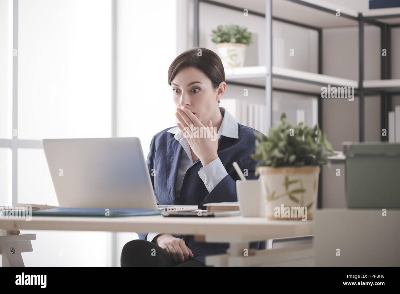 Young businesswoman having problems with her computer, she is staring ...