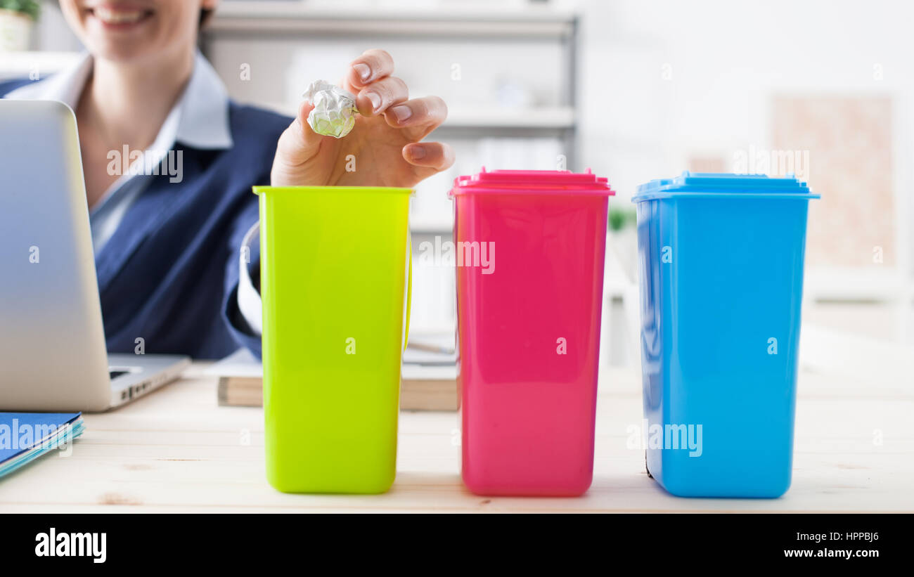 Waste separate collection and recycling in the workplace, office worker ...