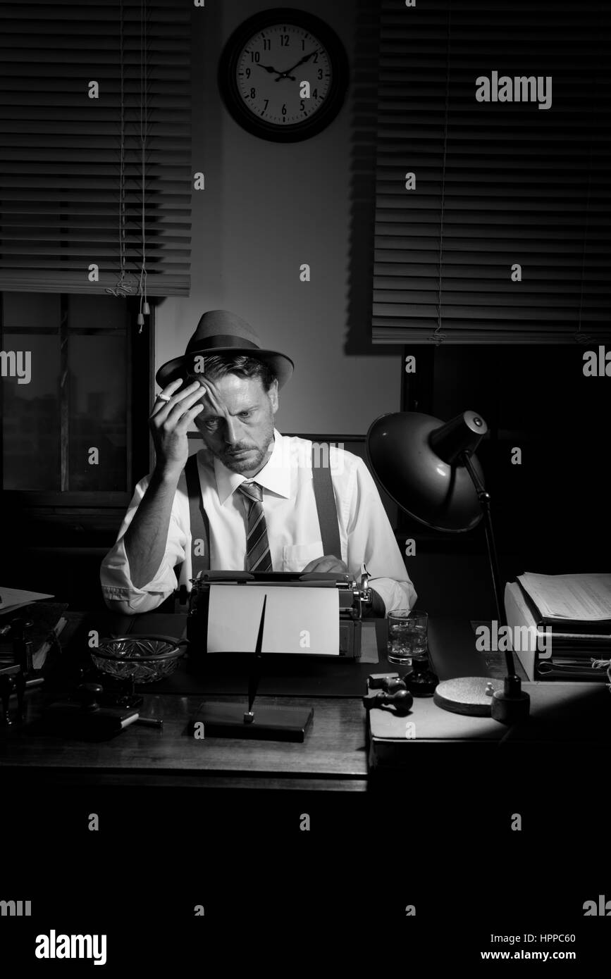 Reporter working late at night and smoking in his office, 1950s film ...