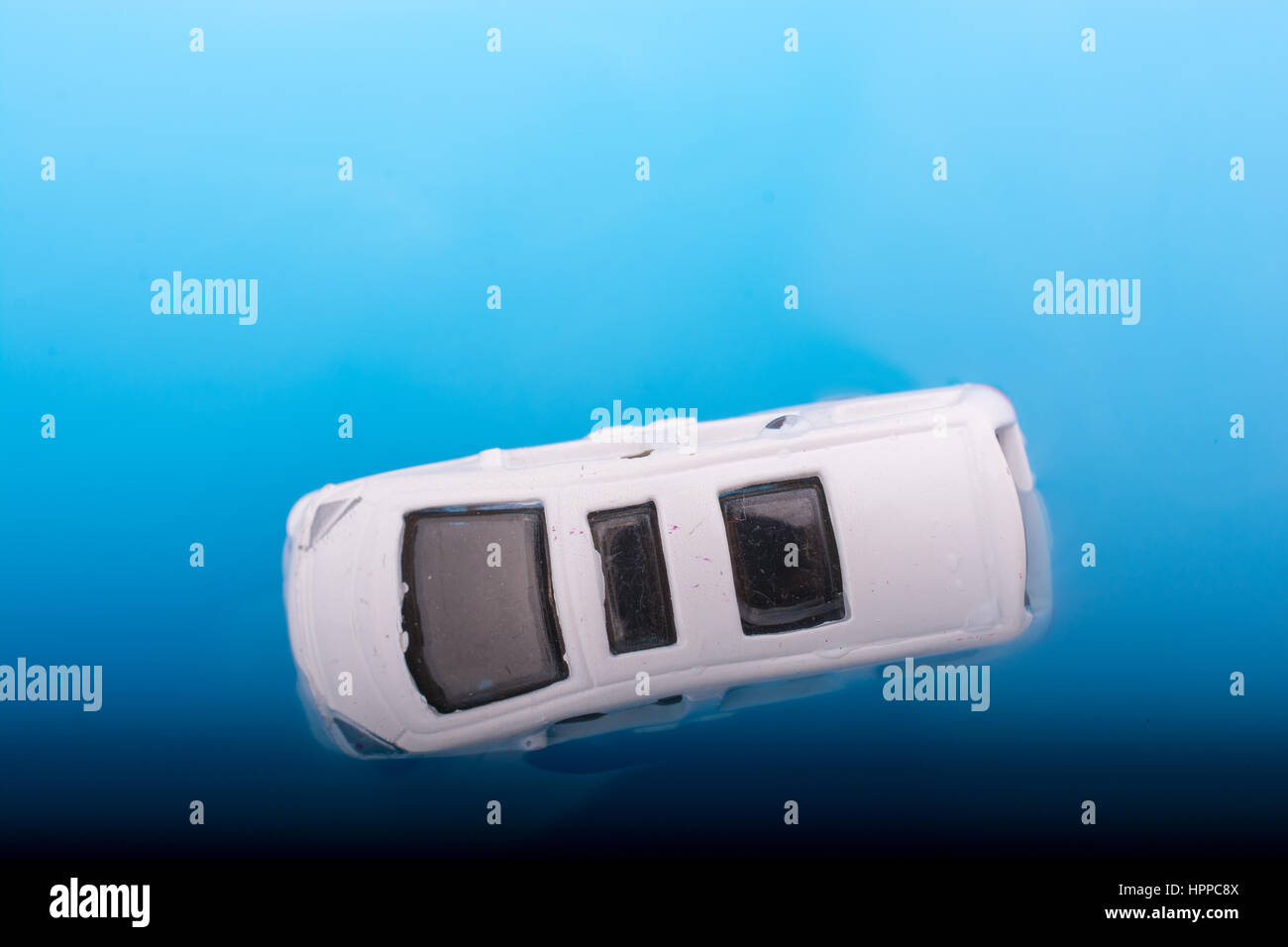 Little toy car floats in blue water Stock Photo - Alamy