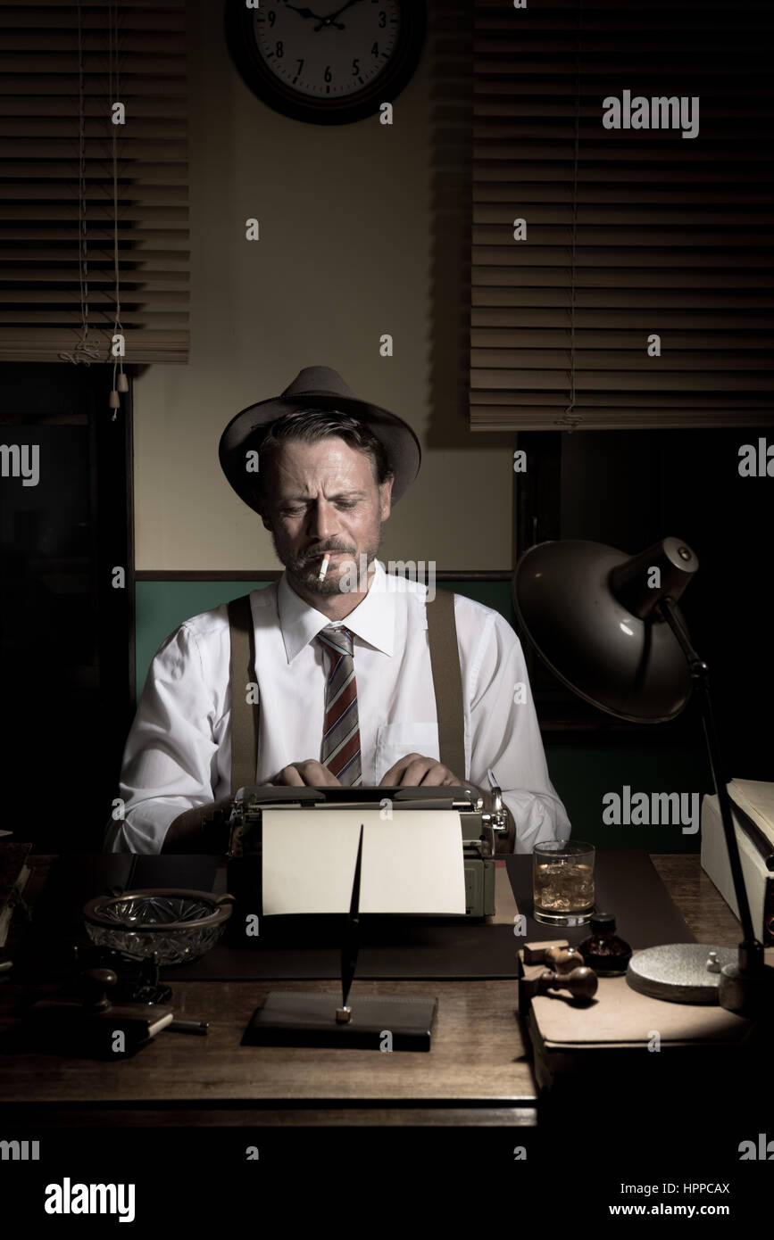 Reporter working late at night and smoking in his office, 1950s film ...
