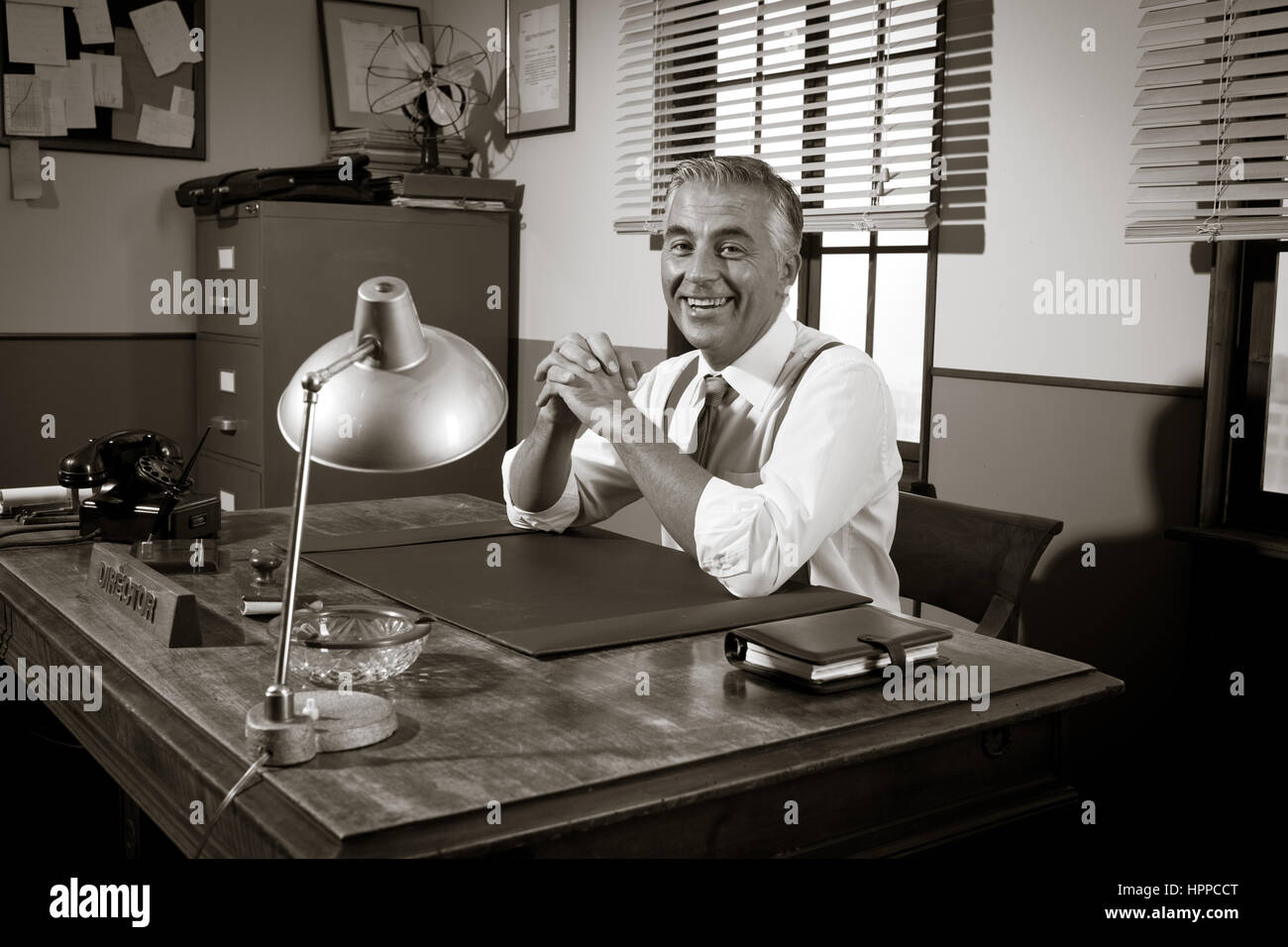 Cheerful director sitting at office desk, 1950s vintage office Stock ...