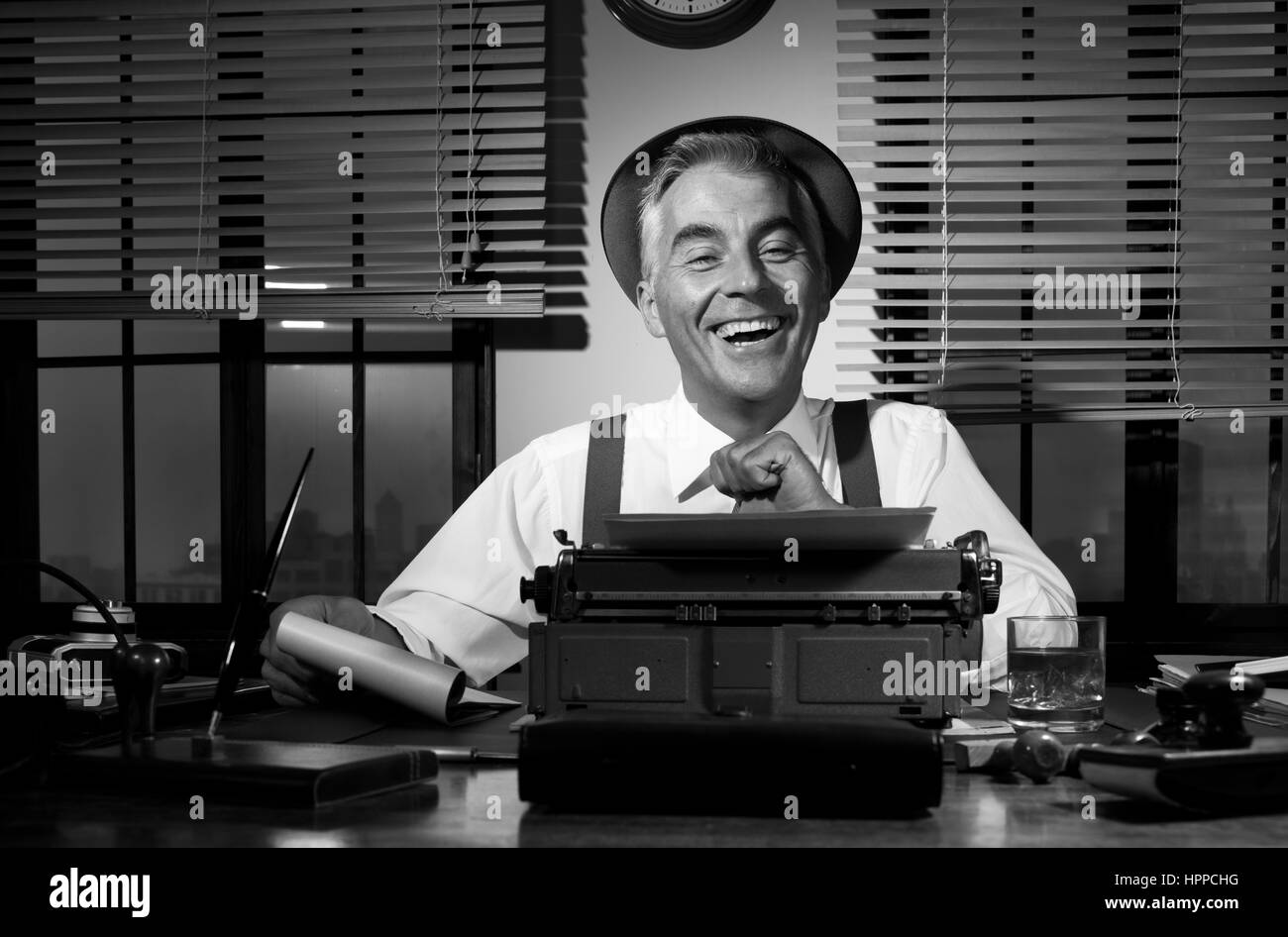 Professional reporter at work writing down notes, 1950s style office ...