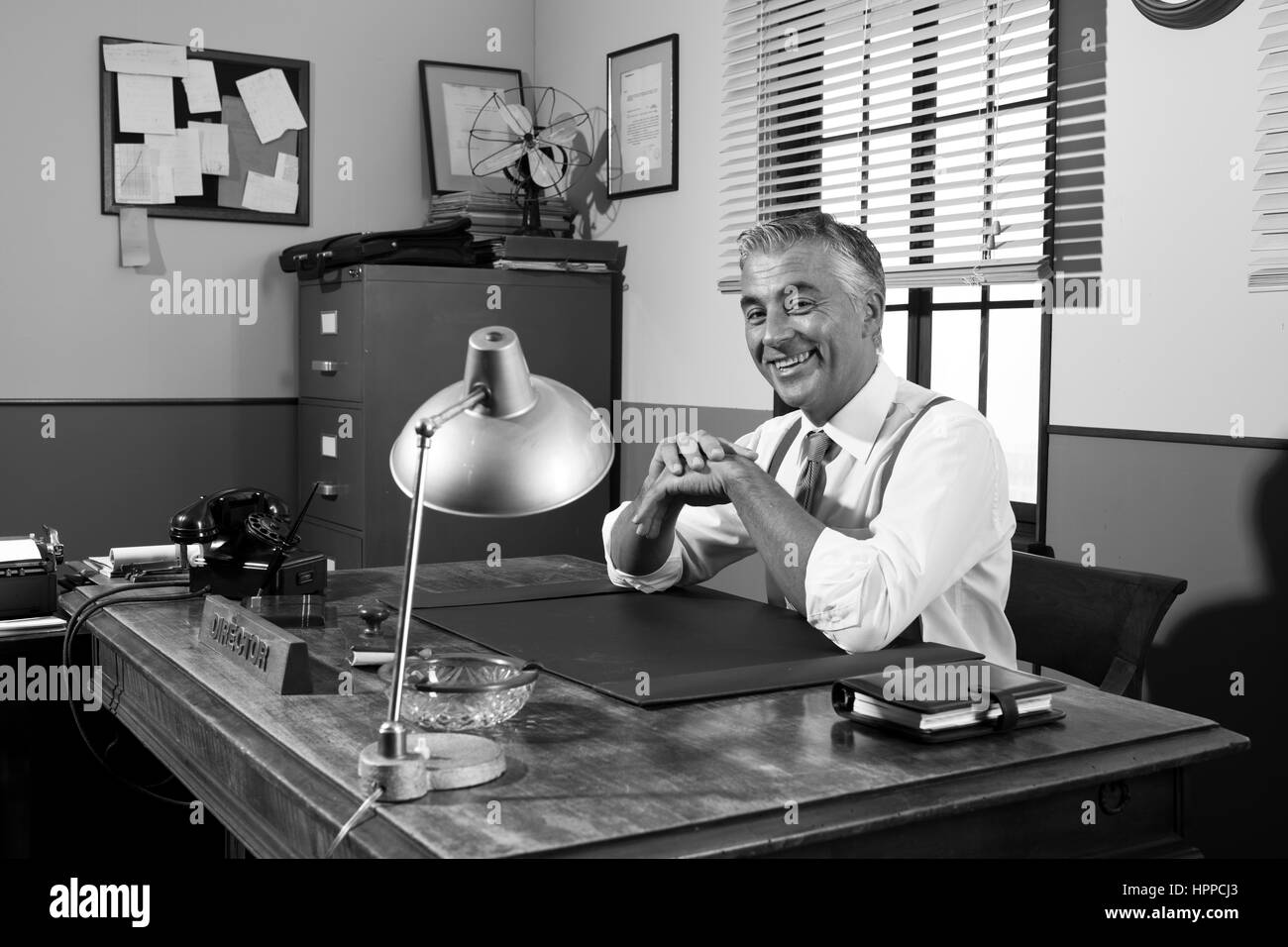 Cheerful director sitting at office desk, 1950s vintage office Stock ...