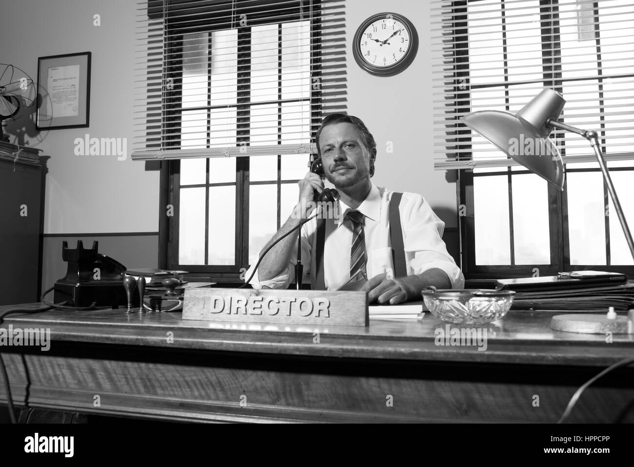 1950s style office: director smiling and talking on the phone Stock ...