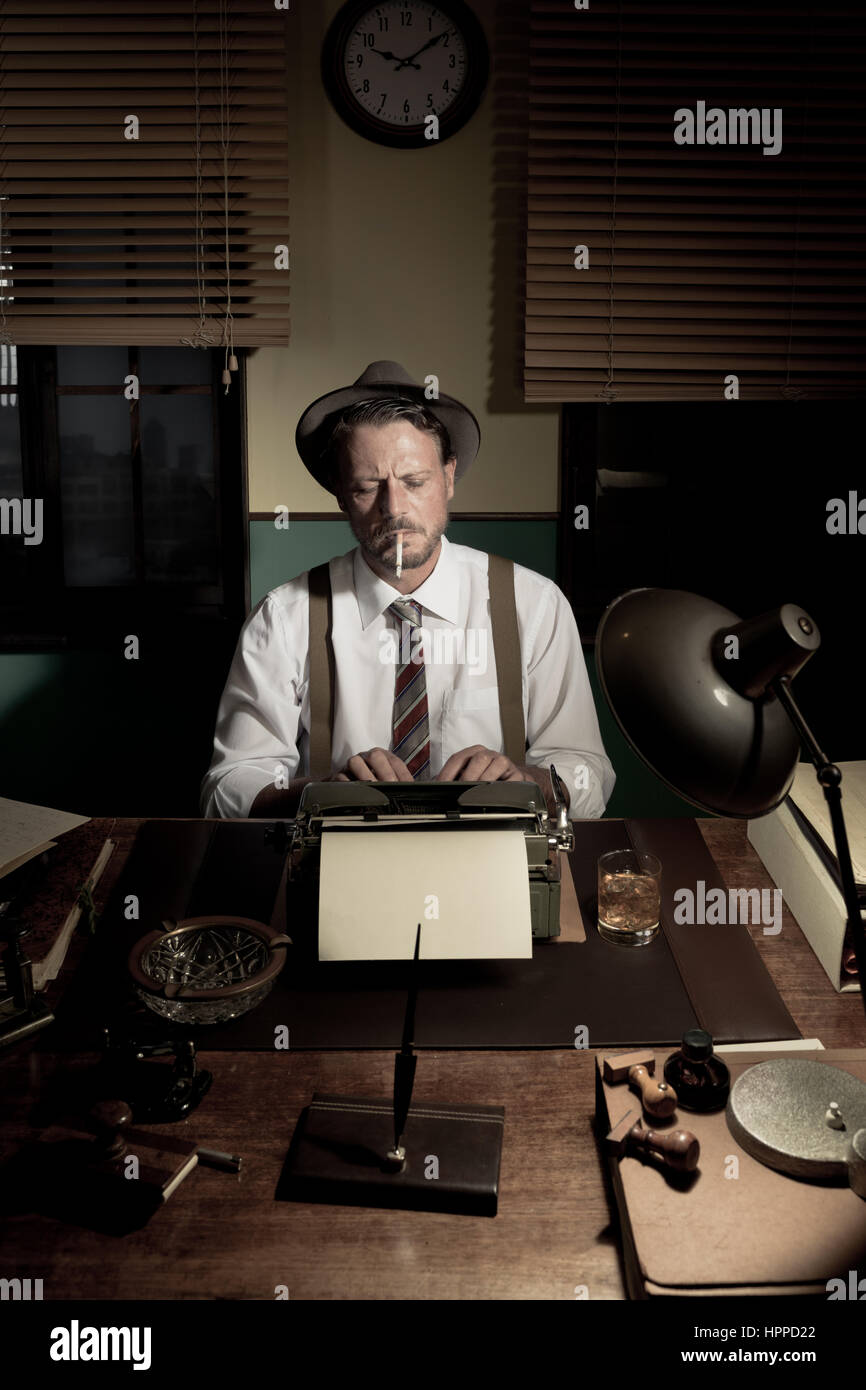 Reporter working late at night and smoking in his office, 1950s film ...
