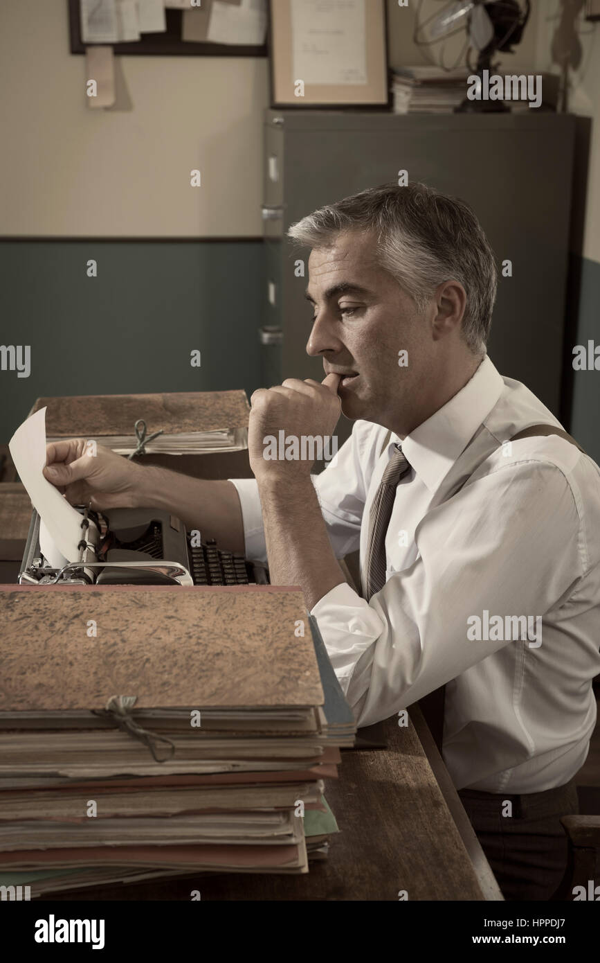 Retro journalist working at office desk and proofreading a text Stock ...