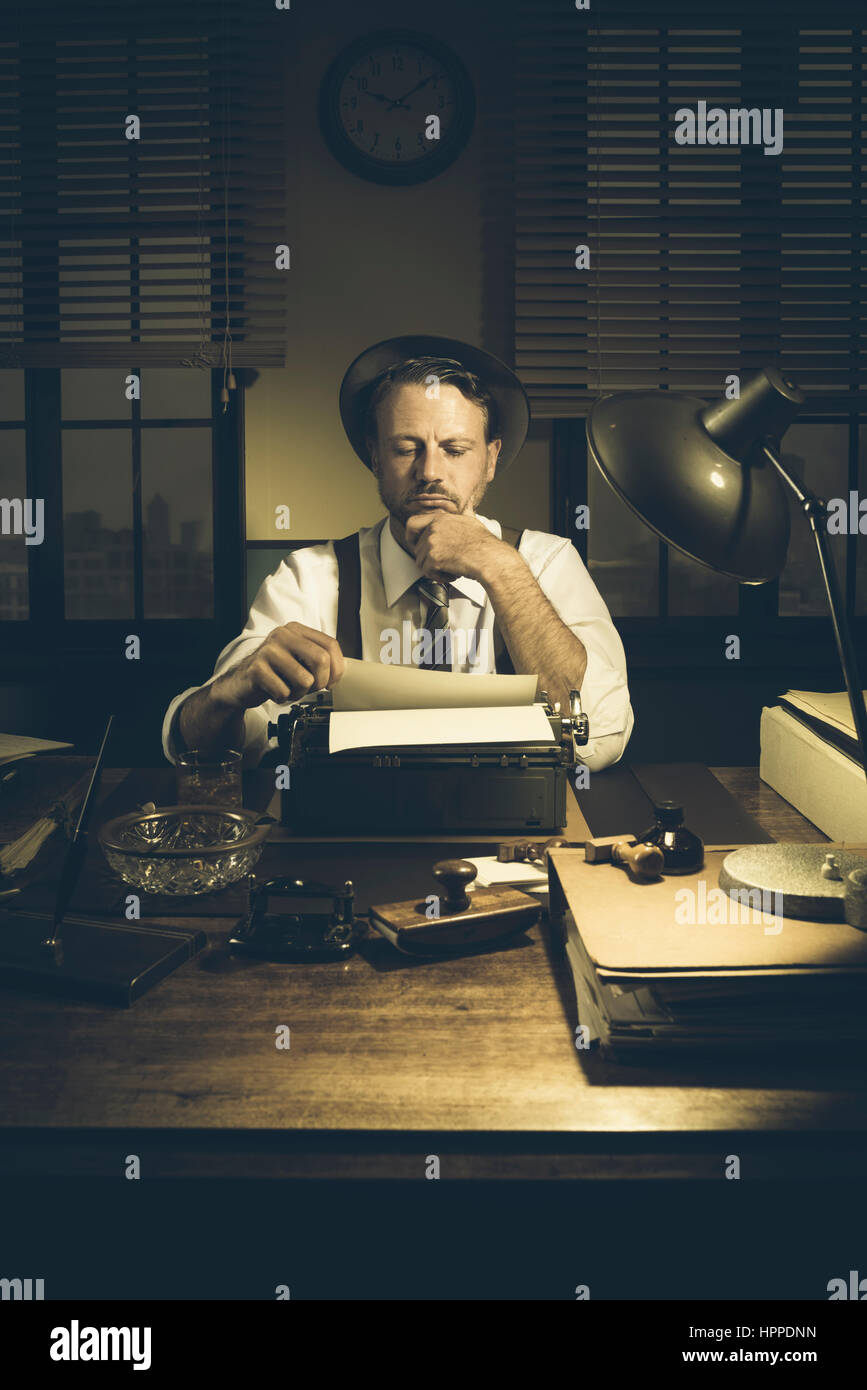 Confident journalist checking errors on text working at his desk, 1950s ...