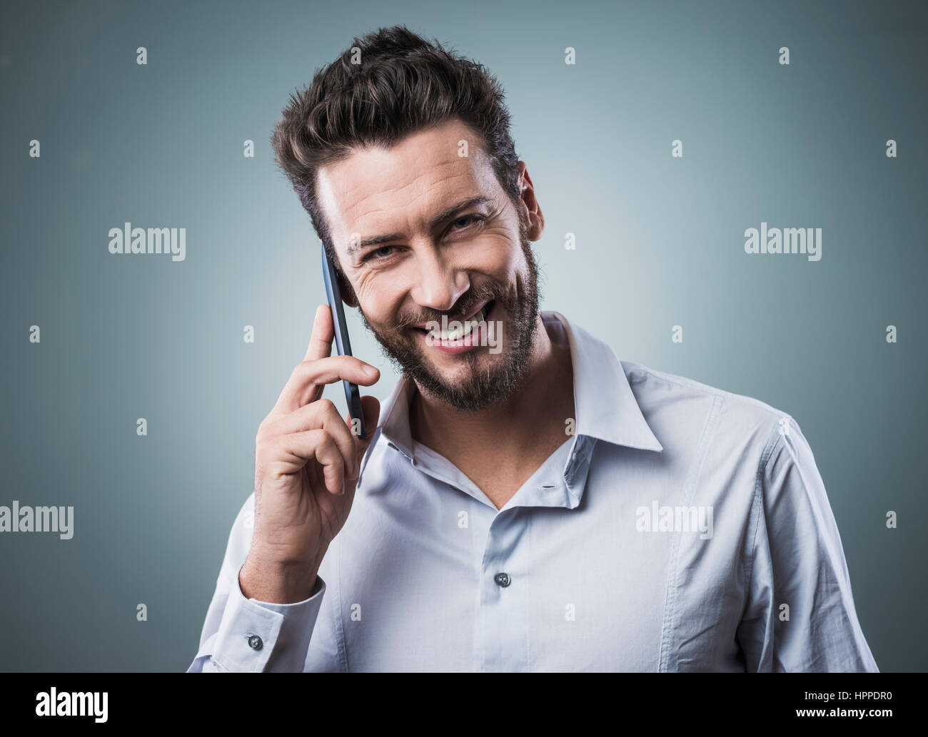 Smiling young businessman having a phone call with his mobile Stock ...