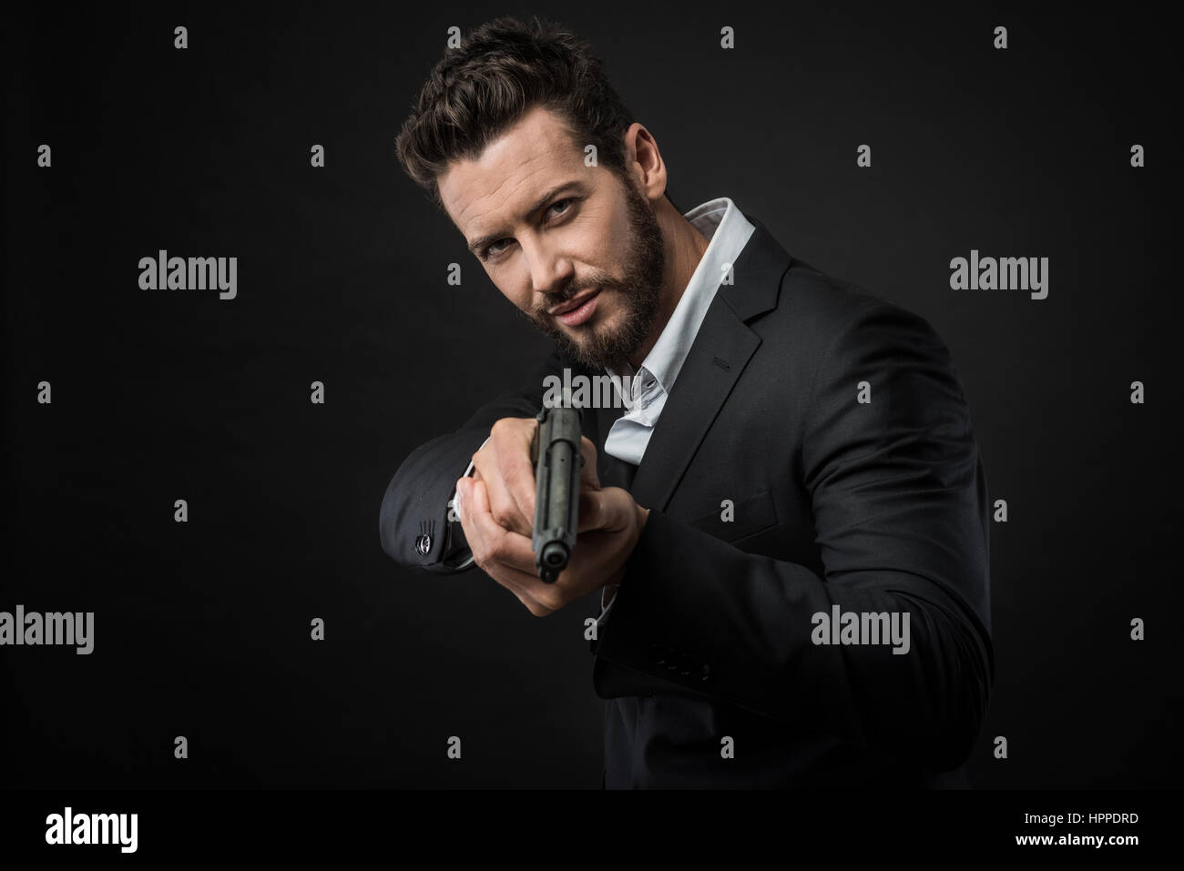 Cool aggressive man in shirt and jacket pointing a gun Stock Photo - Alamy