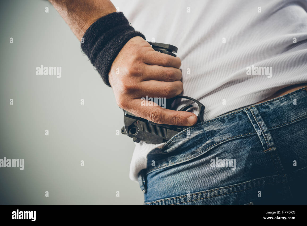Man grabbing quickly a pistol, hands close up Stock Photo - Alamy