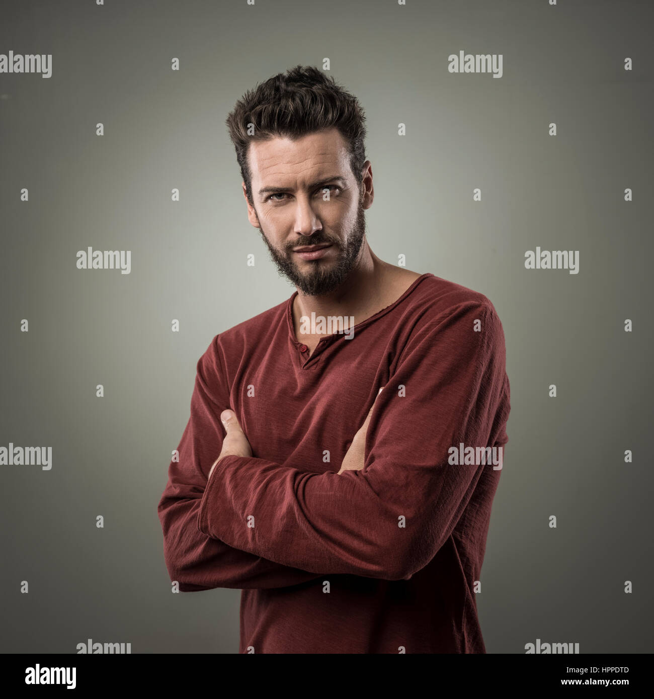 Confident young man posing with arms crossed, strong attitude Stock ...
