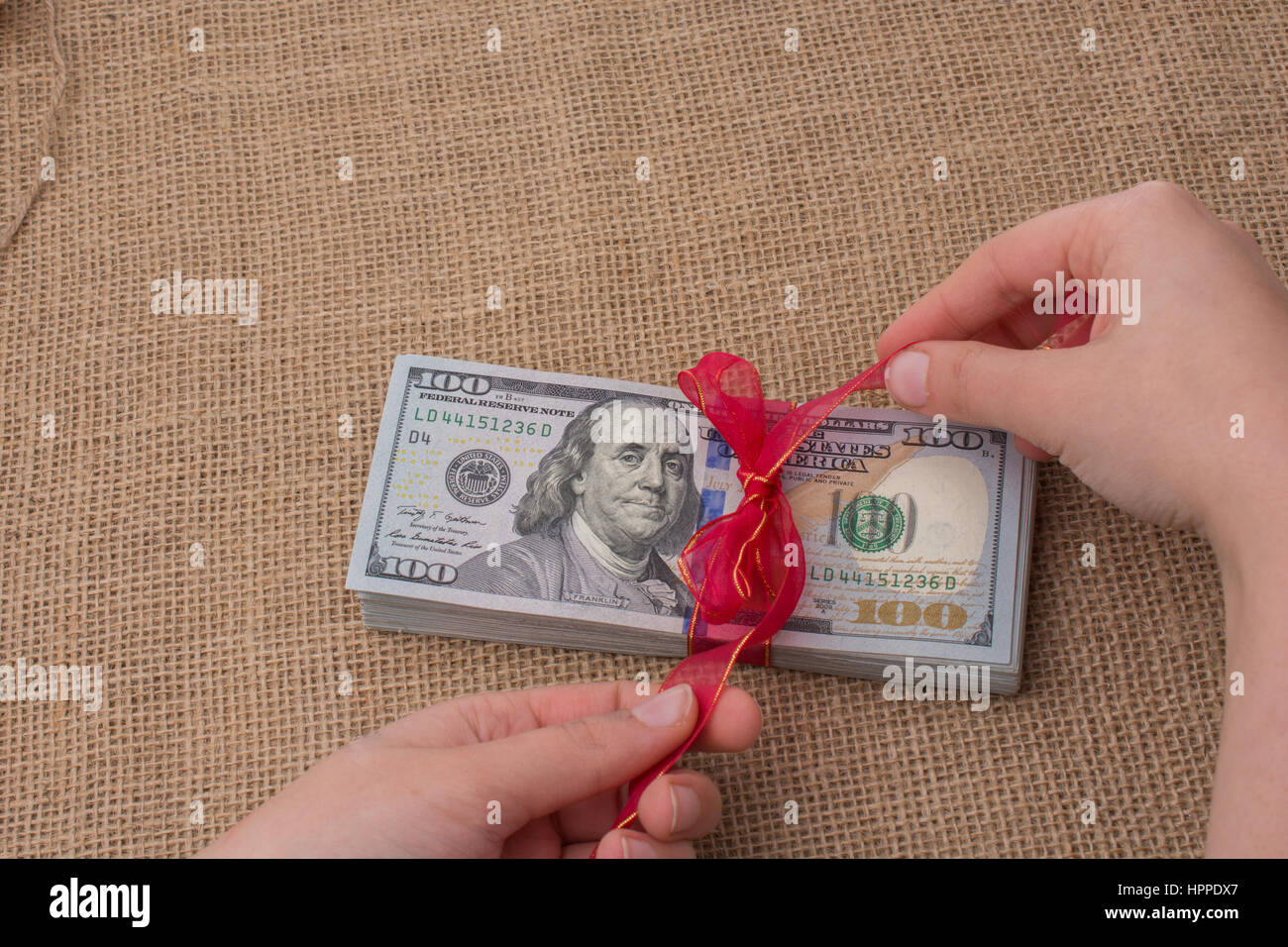 Banknote bundle of US dollar tied with colorful a ribbon Stock Photo ...