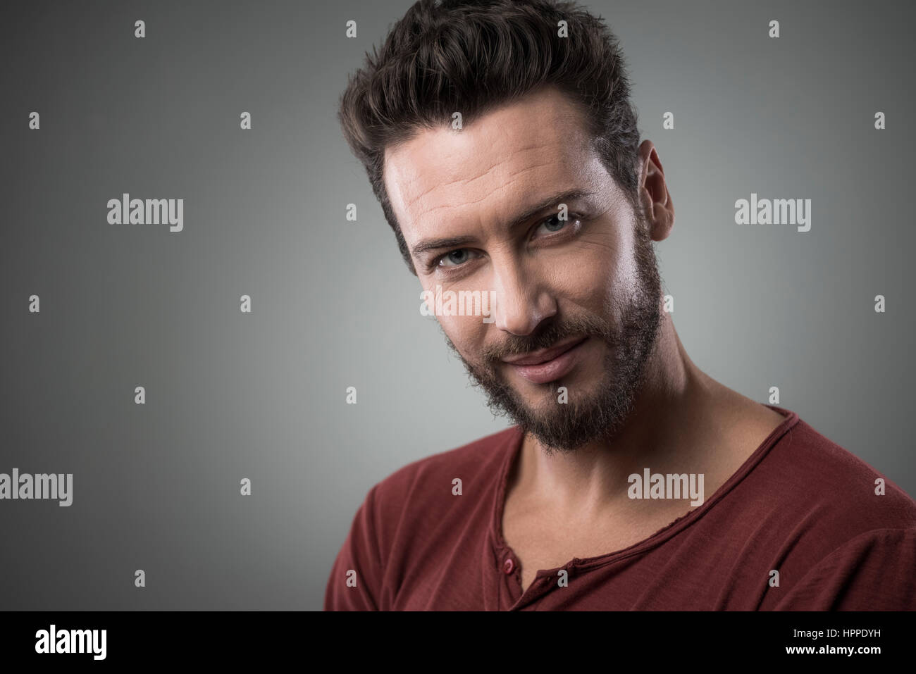 Smiling attractive young man flirting and smiling at camera Stock Photo ...