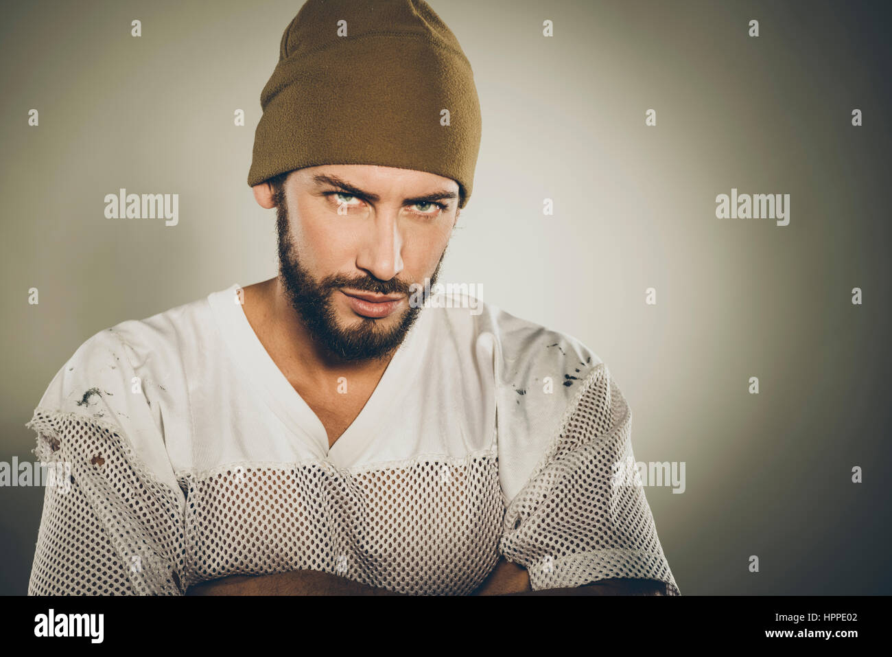 Aggressive bad boy posing and staring at camera Stock Photo - Alamy