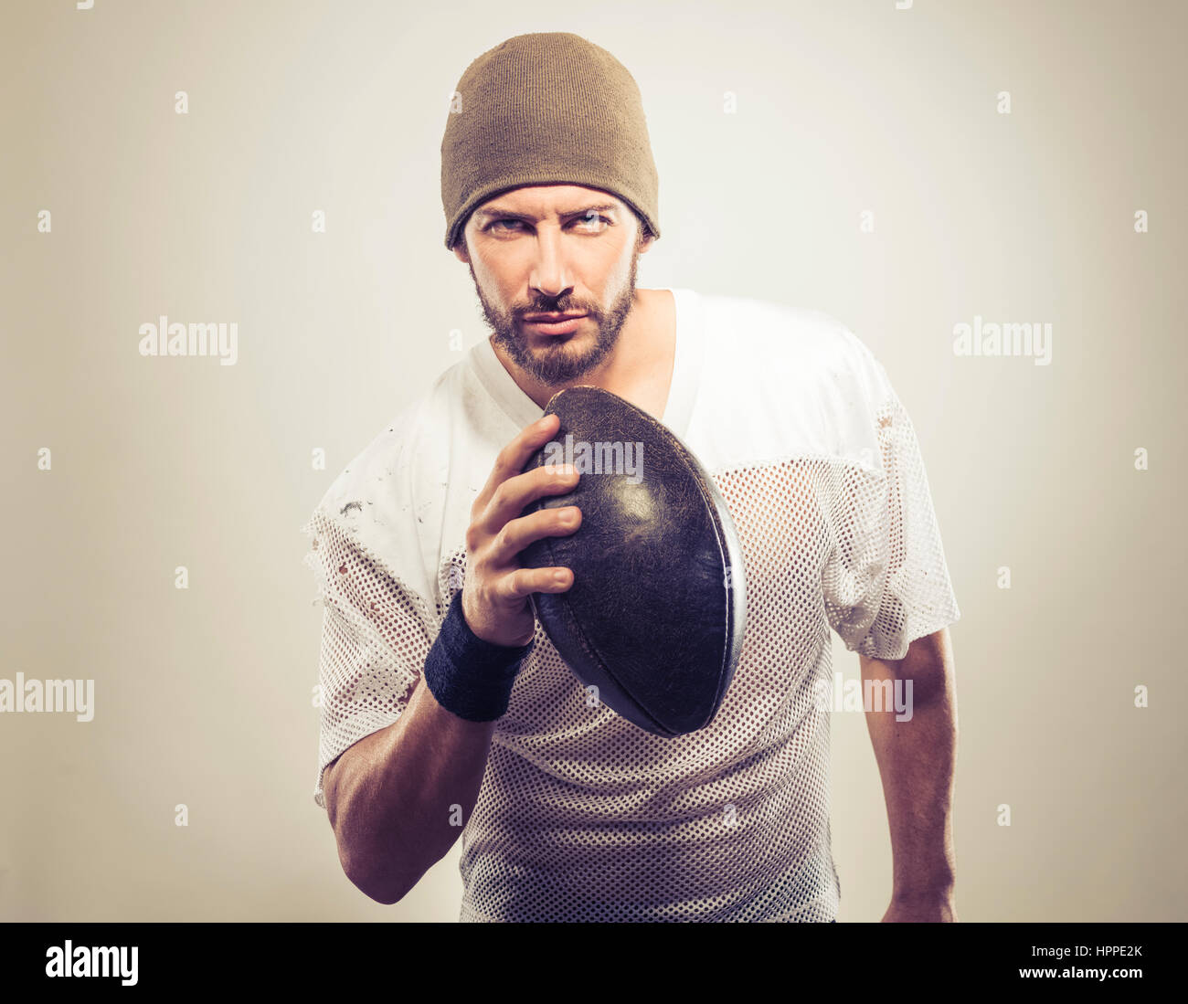Handsome muscular football player holding ball and posing Stock Photo ...