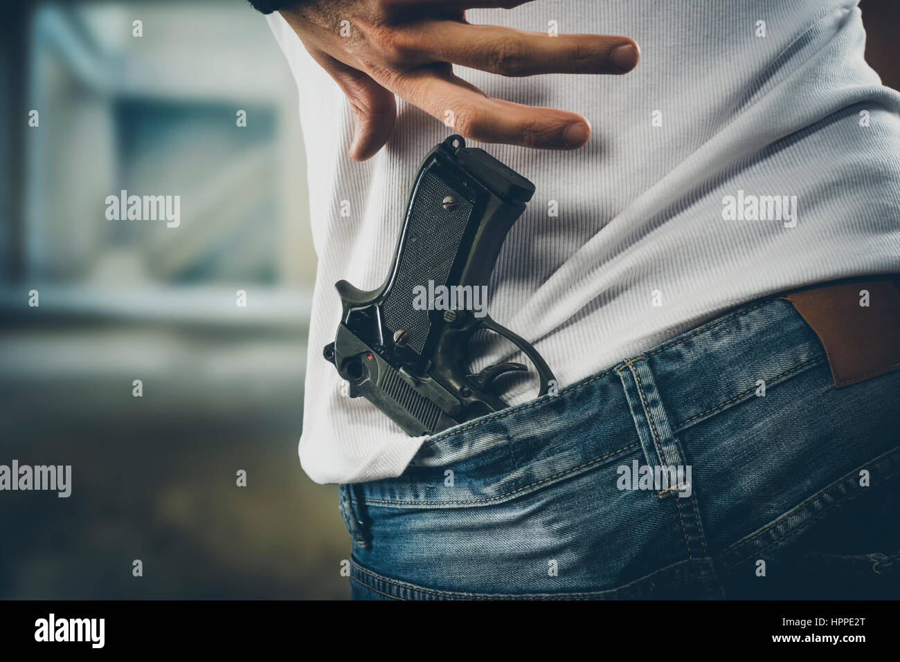 Man grabbing quickly a pistol, hands close up Stock Photo - Alamy