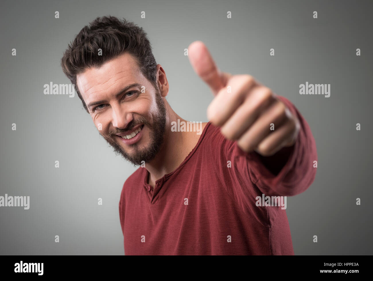 Cool attractive guy thumbs up smiling at camera Stock Photo - Alamy