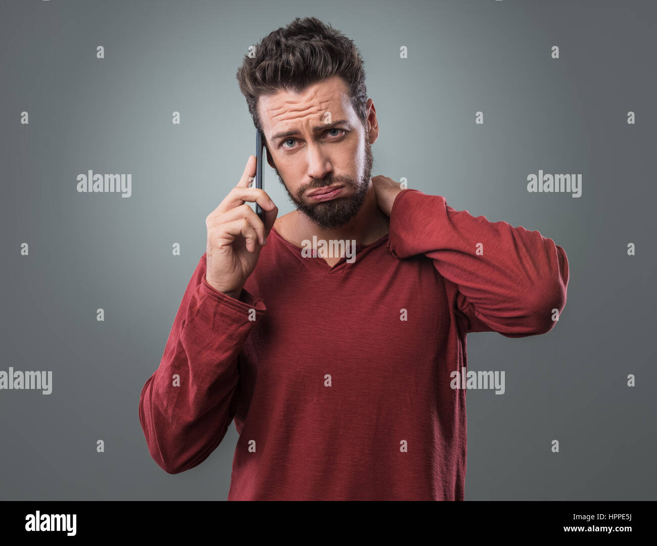 Young man having a boring phone call snorting and frowning Stock Photo ...