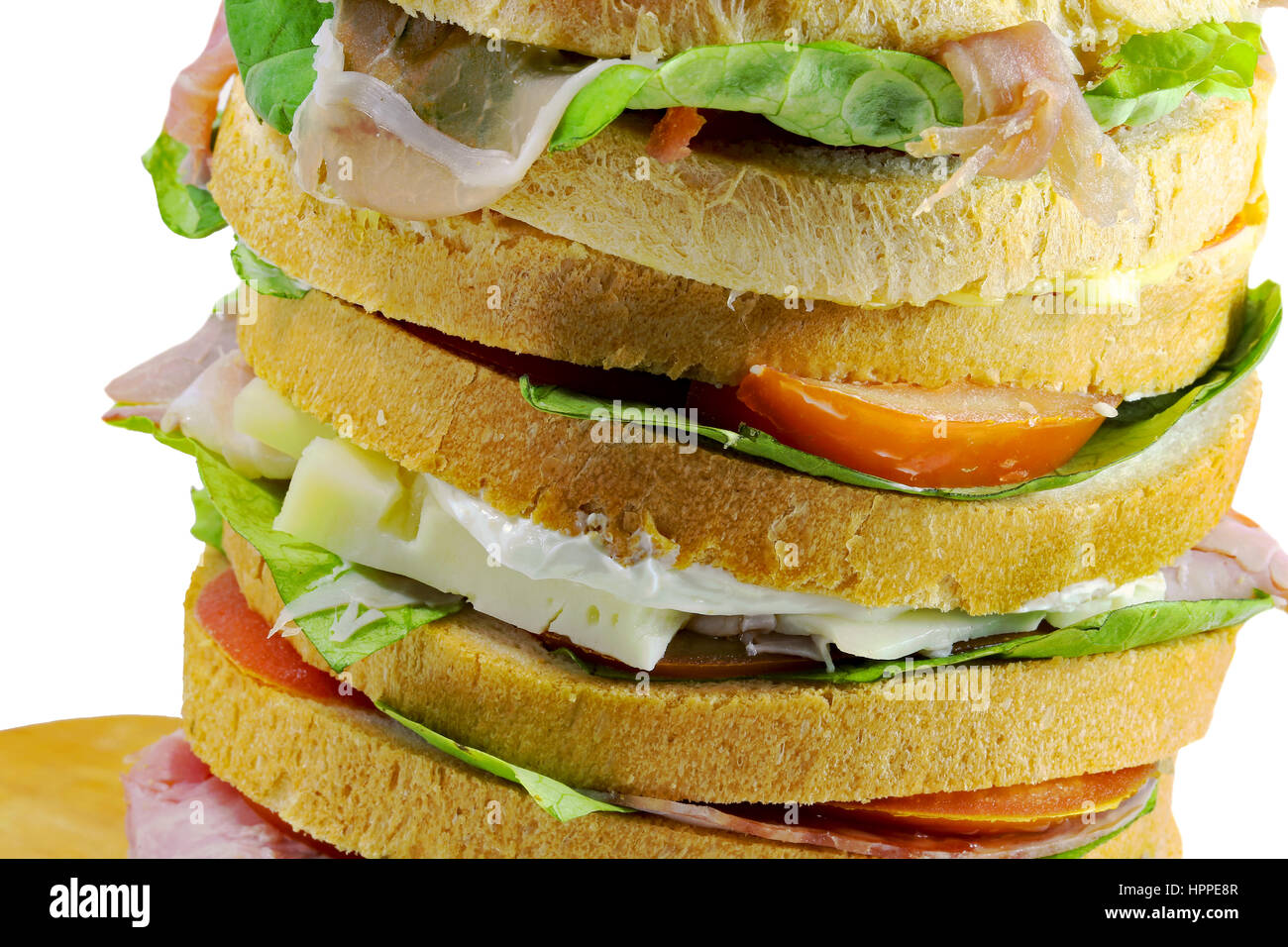 giant sandwich stuffed with many layers of bread with lettuce tomato ...