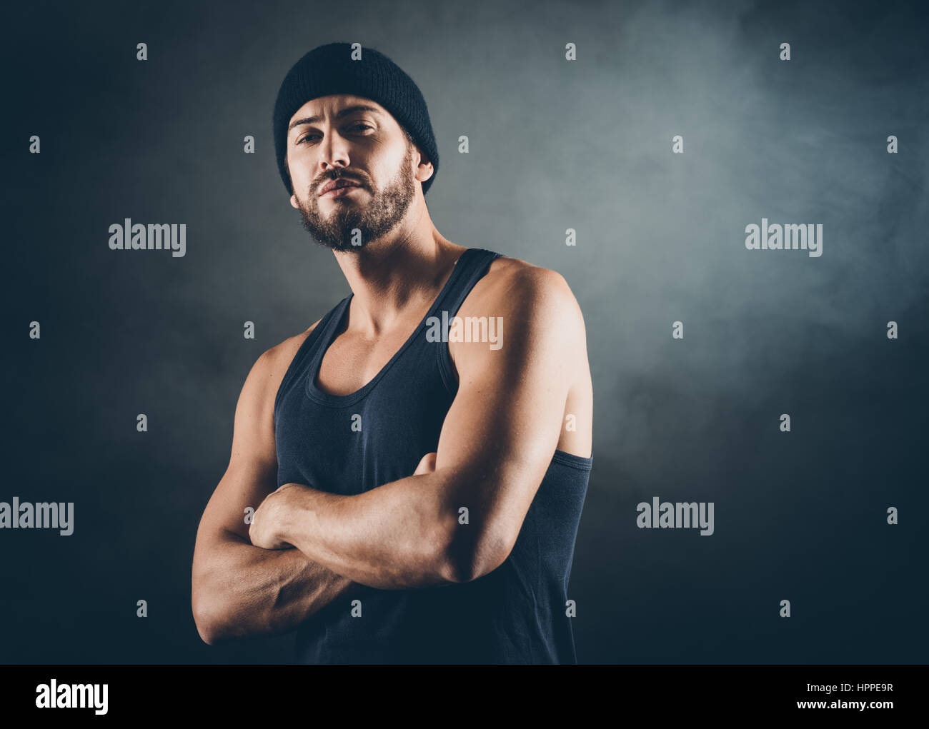 Cool bad boy with strong attitude posing arms crossed Stock Photo - Alamy