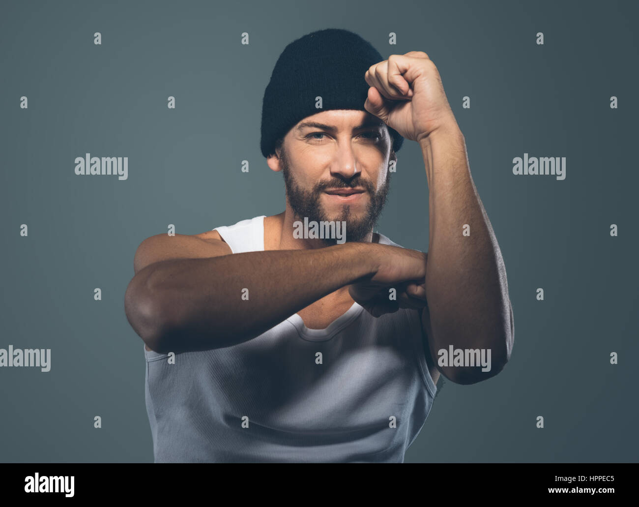 Cool stylish rapper gesturing and smiling at camera Stock Photo - Alamy