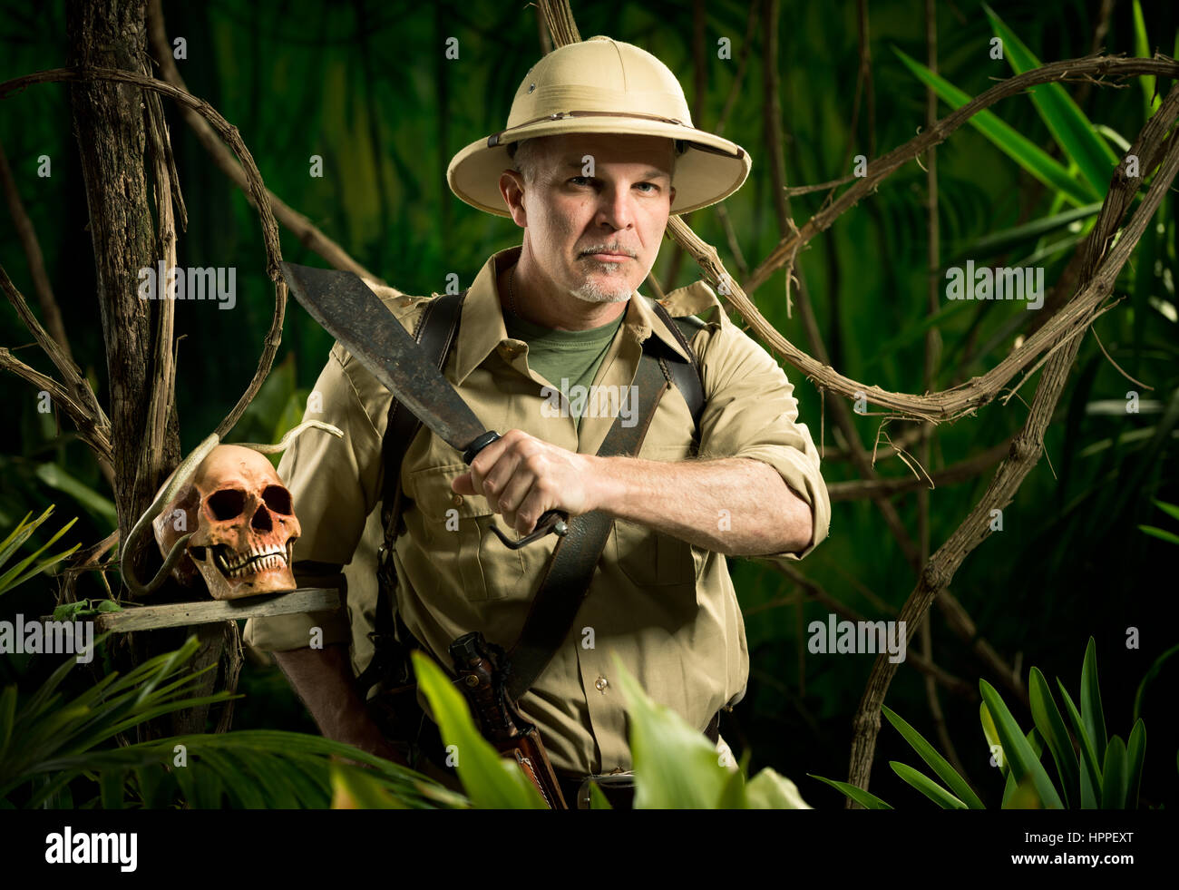 Adventurer with colonial style survival equipment in the jungle with ...