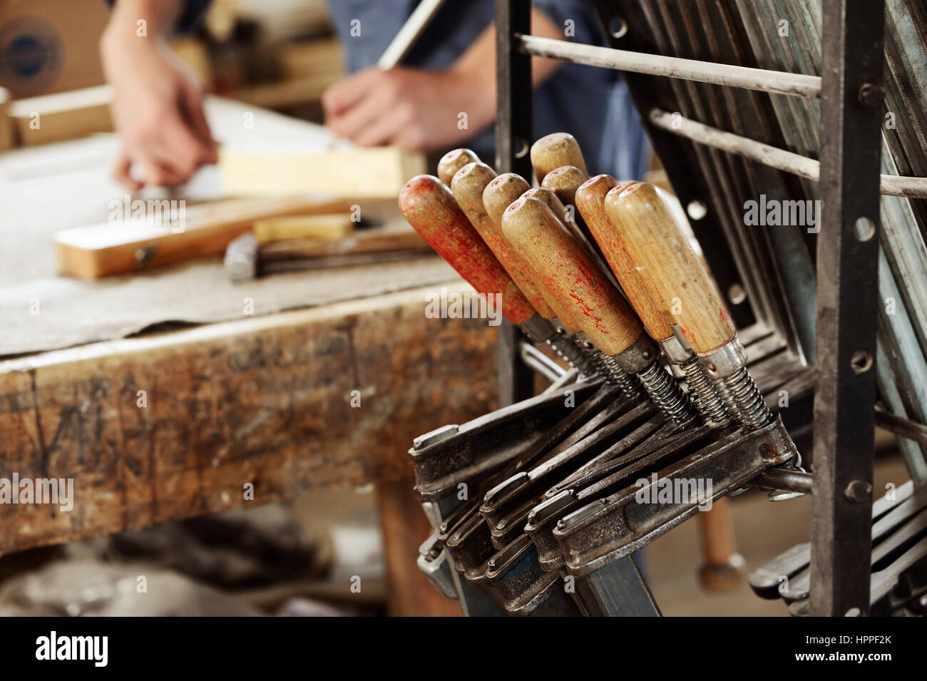 A set of wire saws with carpenter working on background Stock Photo - Alamy