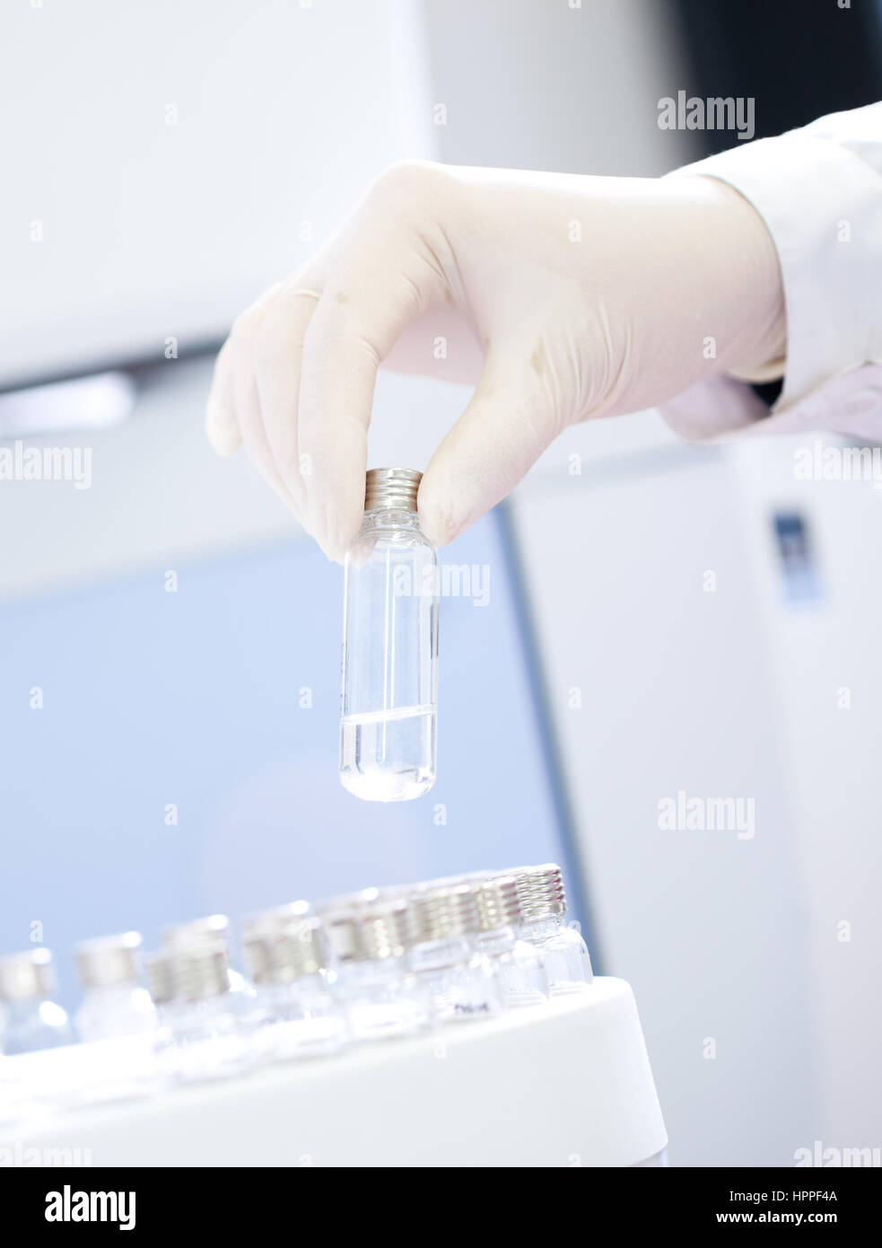 Technician loading sample vials in autosampler rack Stock Photo - Alamy