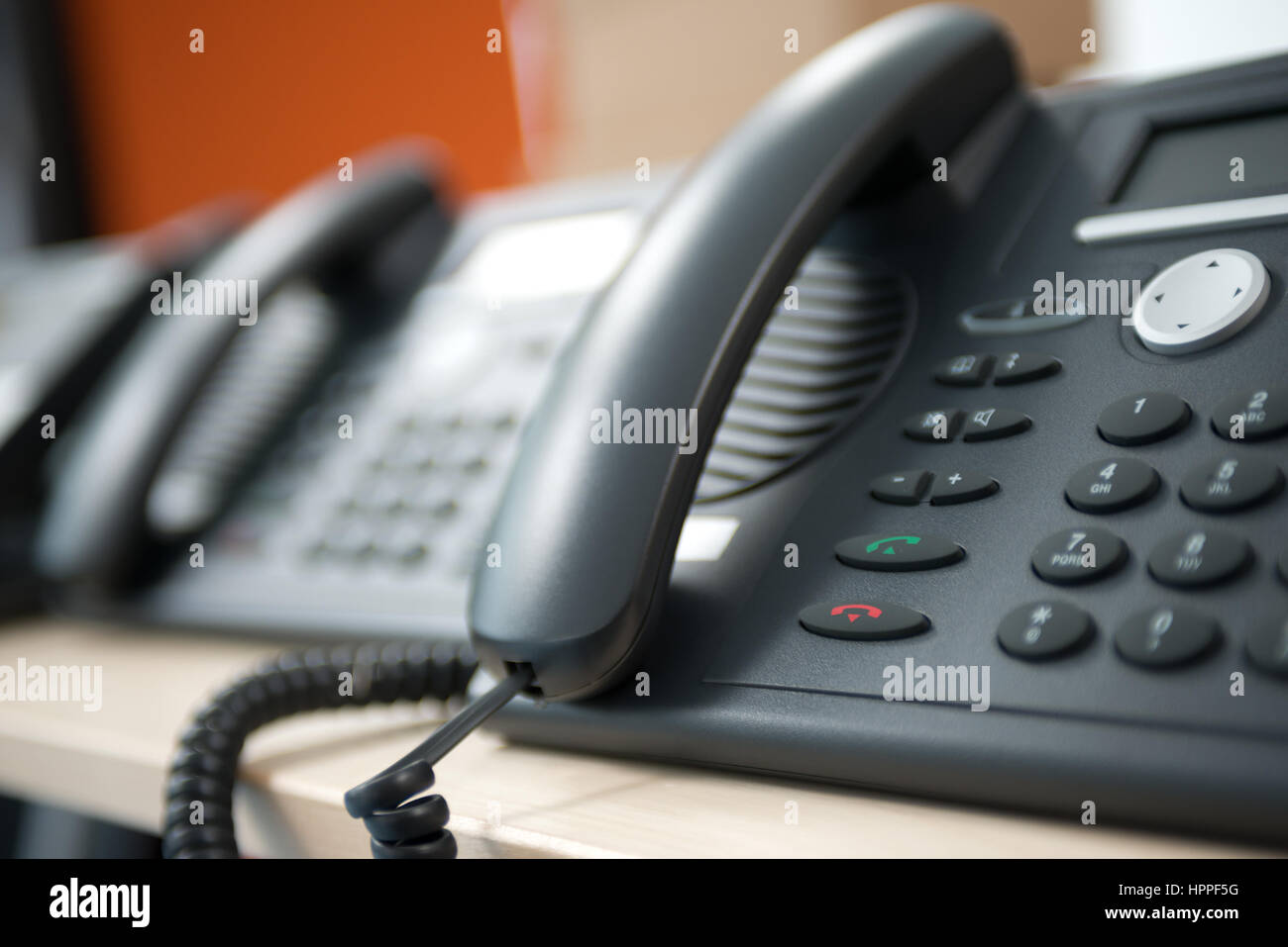 Set of black telephones on a desk, receiver close-up Stock Photo - Alamy