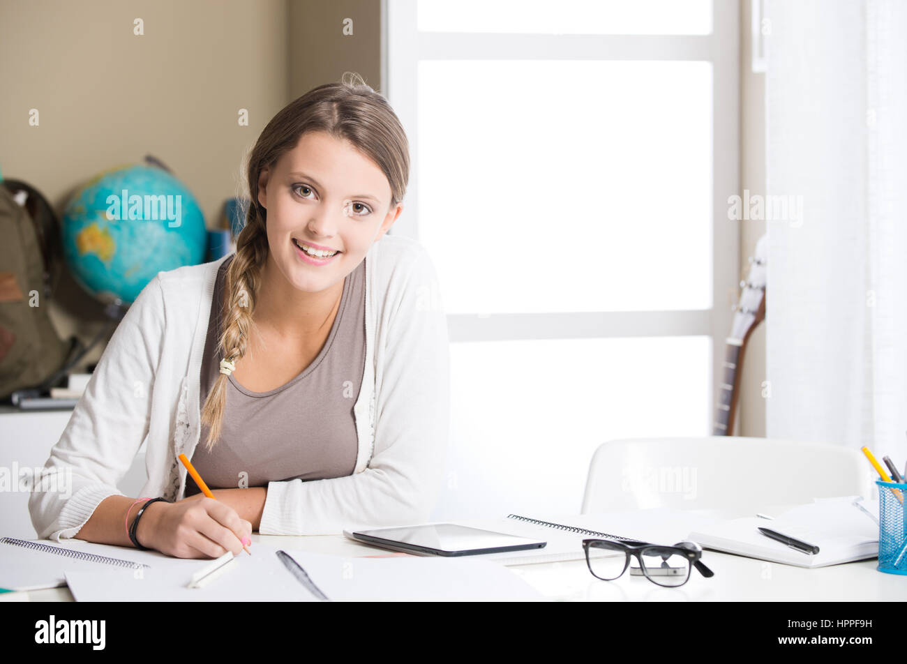 Portrait of a beautiful girl studying at home Stock Photo - Alamy