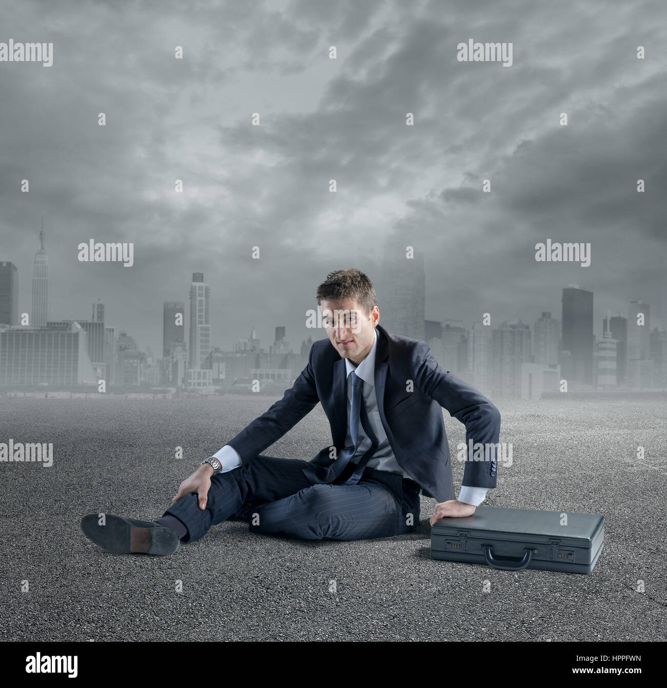Young businessman falling to the ground with post apocalyptic cityscape ...