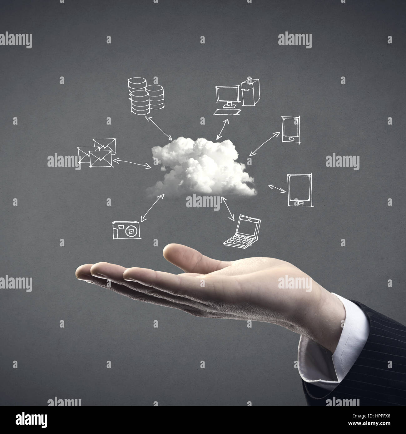 Hand drawn technology and computer icons around cloud with hand on gray ...