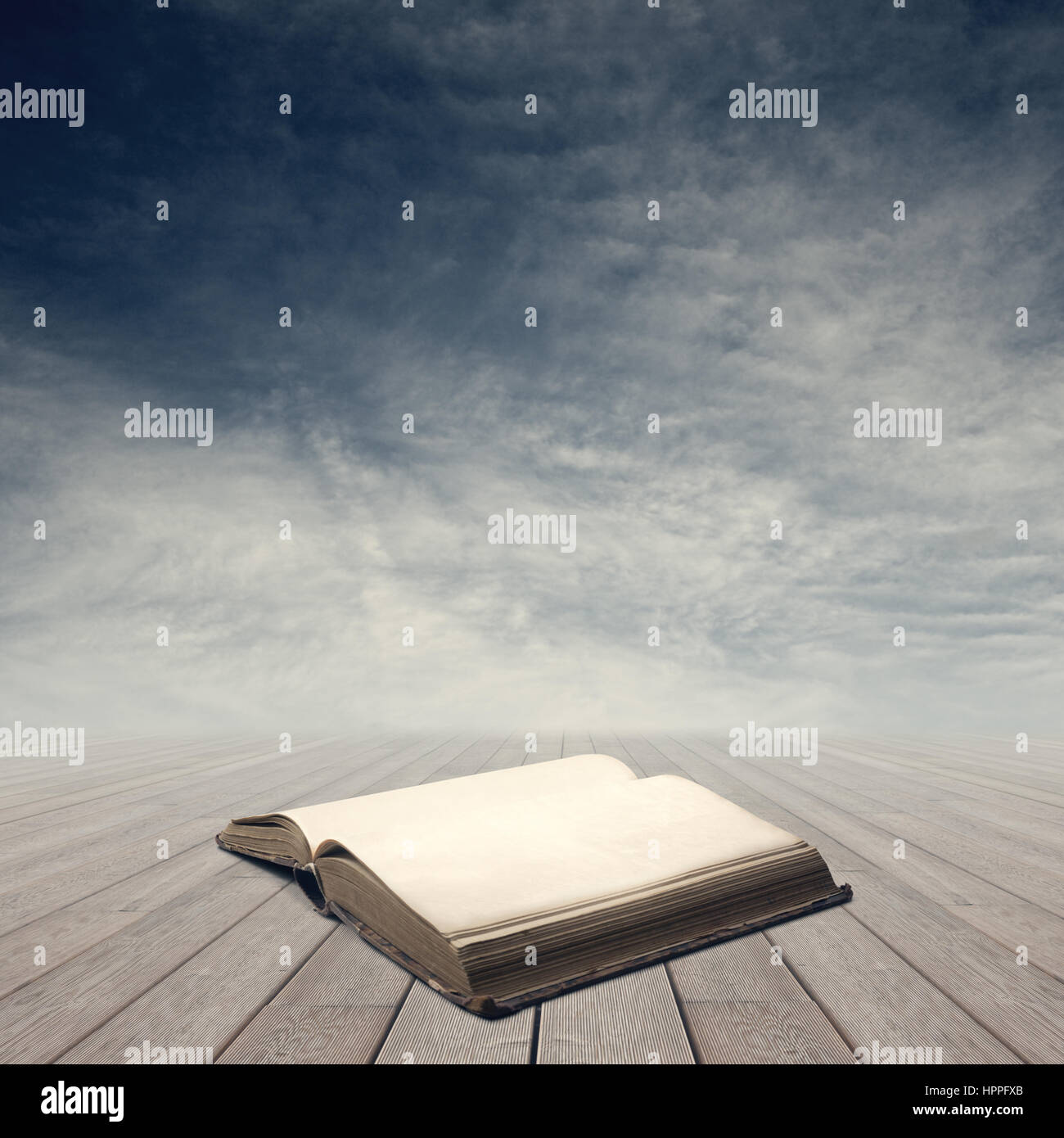 Old open book on wooden planks with blank pages and sky on background ...