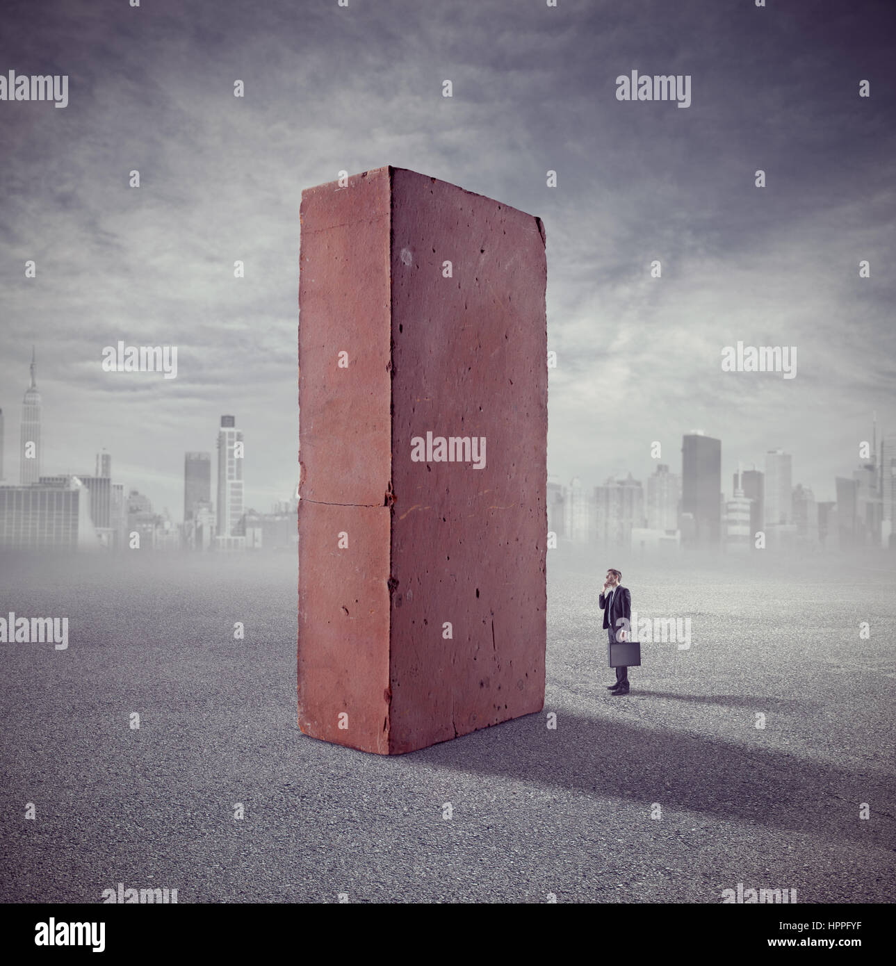 Businessman staring at huge standing brick with skyline and clouds on ...