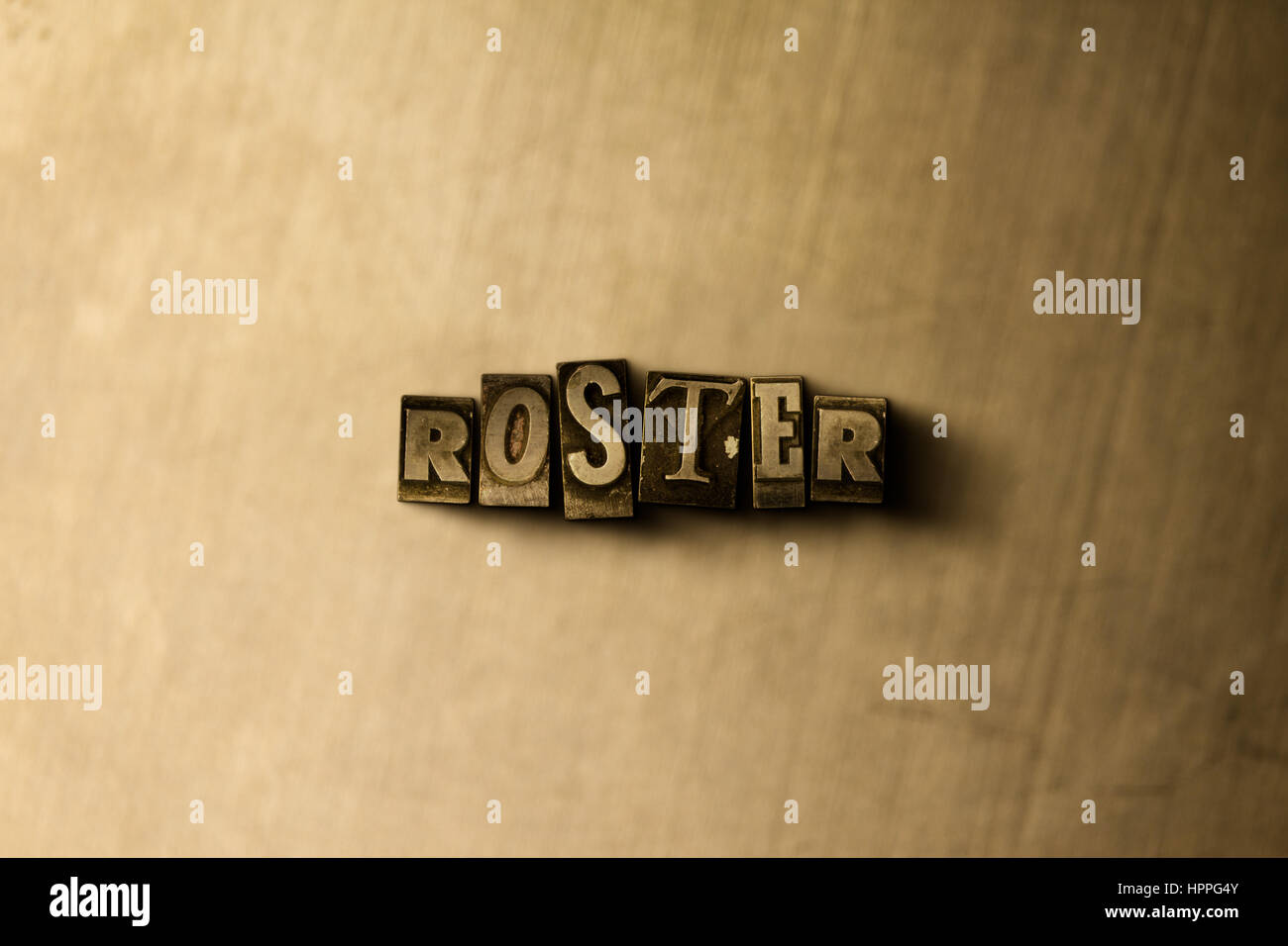 ROSTER - close-up of grungy vintage typeset word on metal backdrop ...