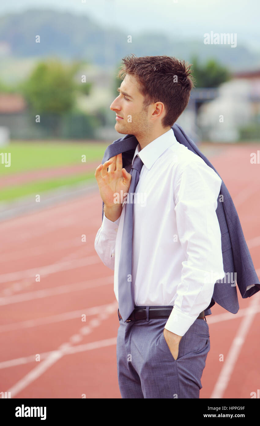 Football coach wearing a man's suit watching the match Stock Photo - Alamy