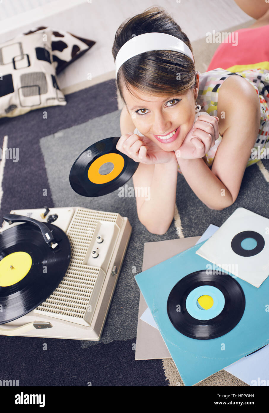 A woman listening to a record. 1960s Stock Photo - Alamy