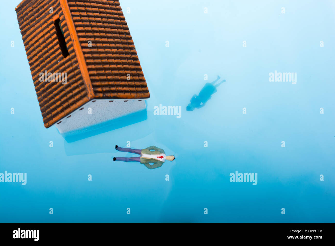 Little model house and figurines of man and woman float in water Stock ...