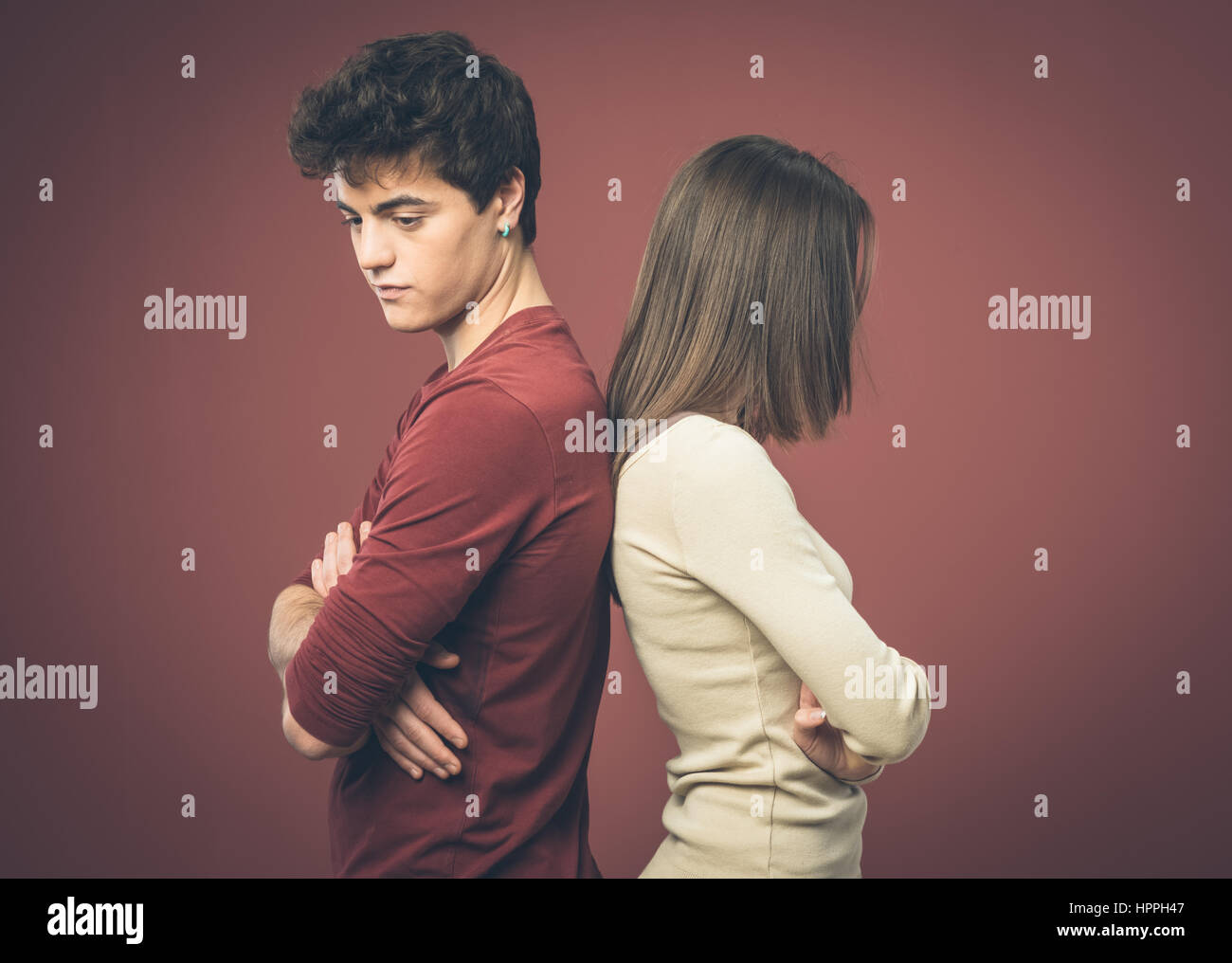 Young sad couple arguing and standing back to back Stock Photo - Alamy