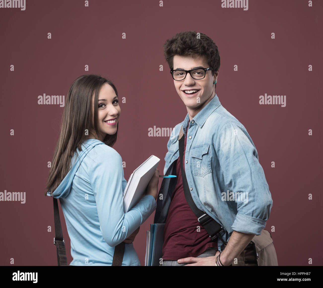 Cheerful smiling students with textbooks hanging out together Stock ...