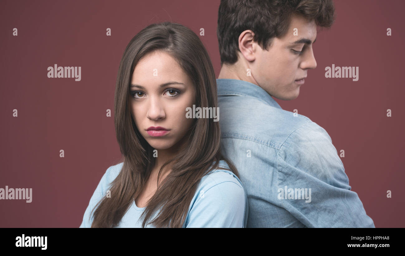 Young sad couple arguing and standing back to back Stock Photo - Alamy