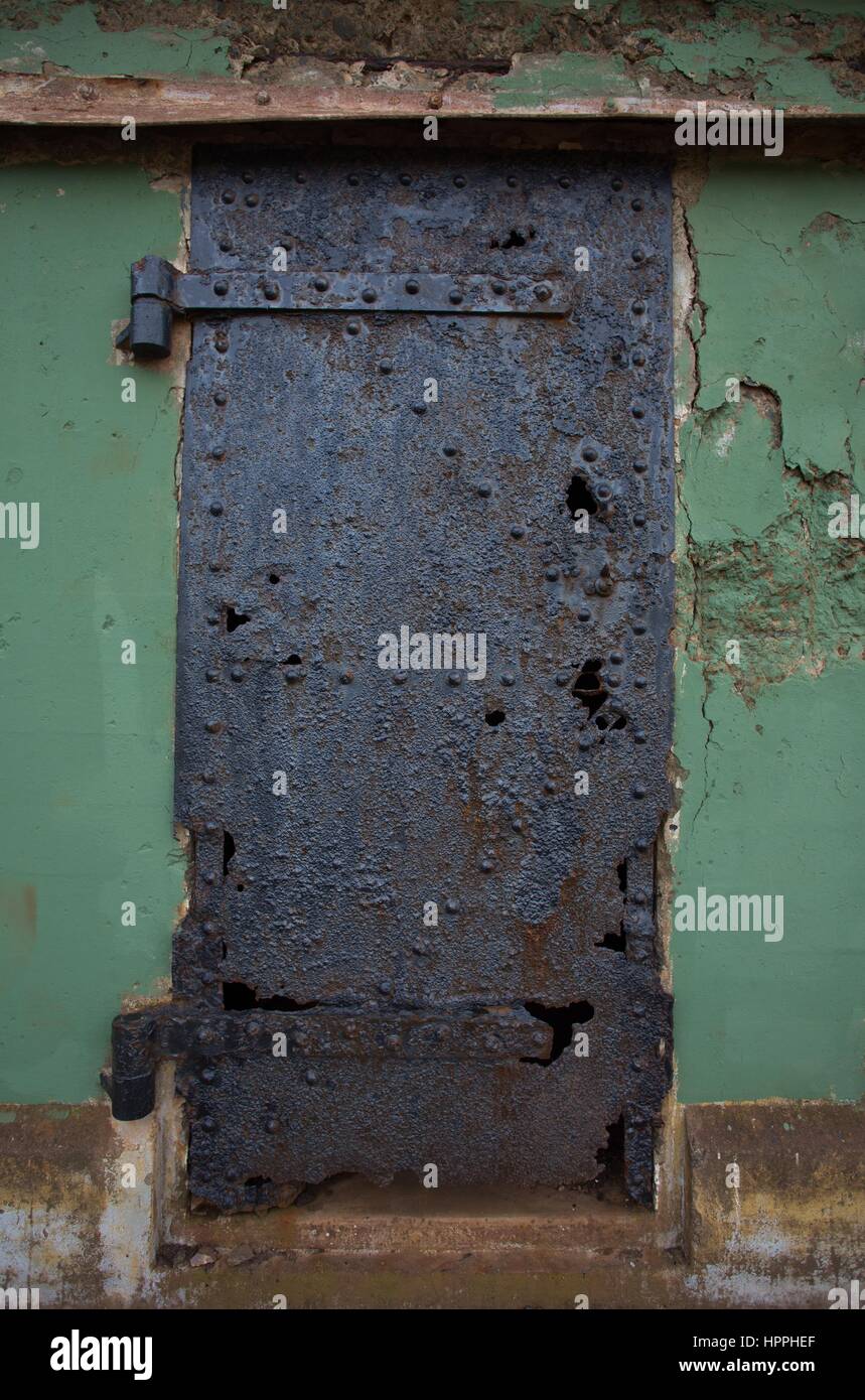 A rusty, corroded metal door at Battery Mendell, an abandoned military ...