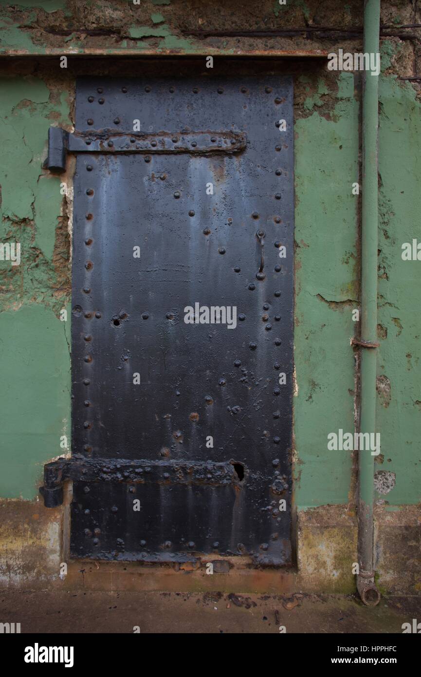 A rusty, corroded metal door at Battery Mendell, an abandoned military ...